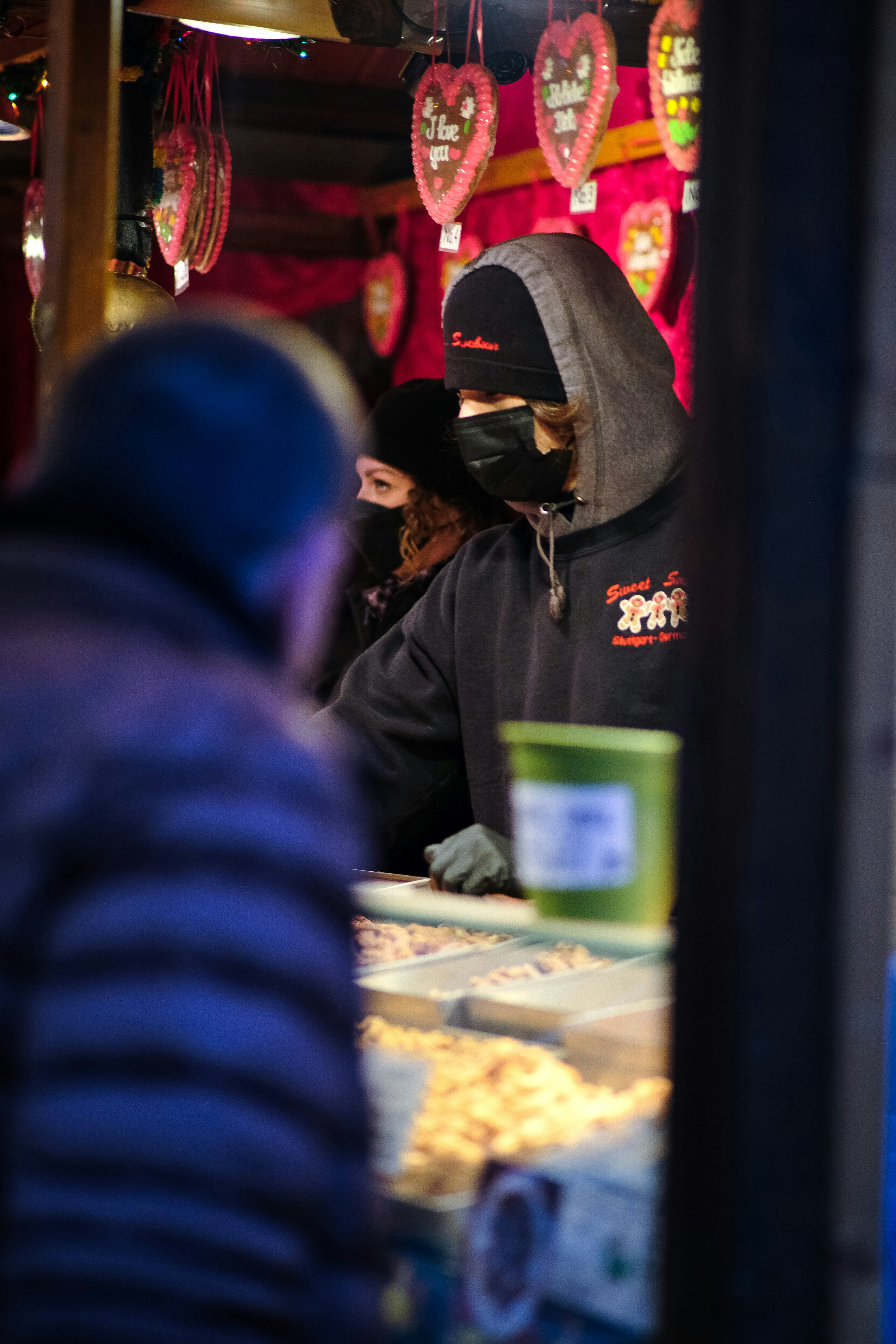 Neon-Glow at the Gingerbread Market: A Masked Vendor at Dusk