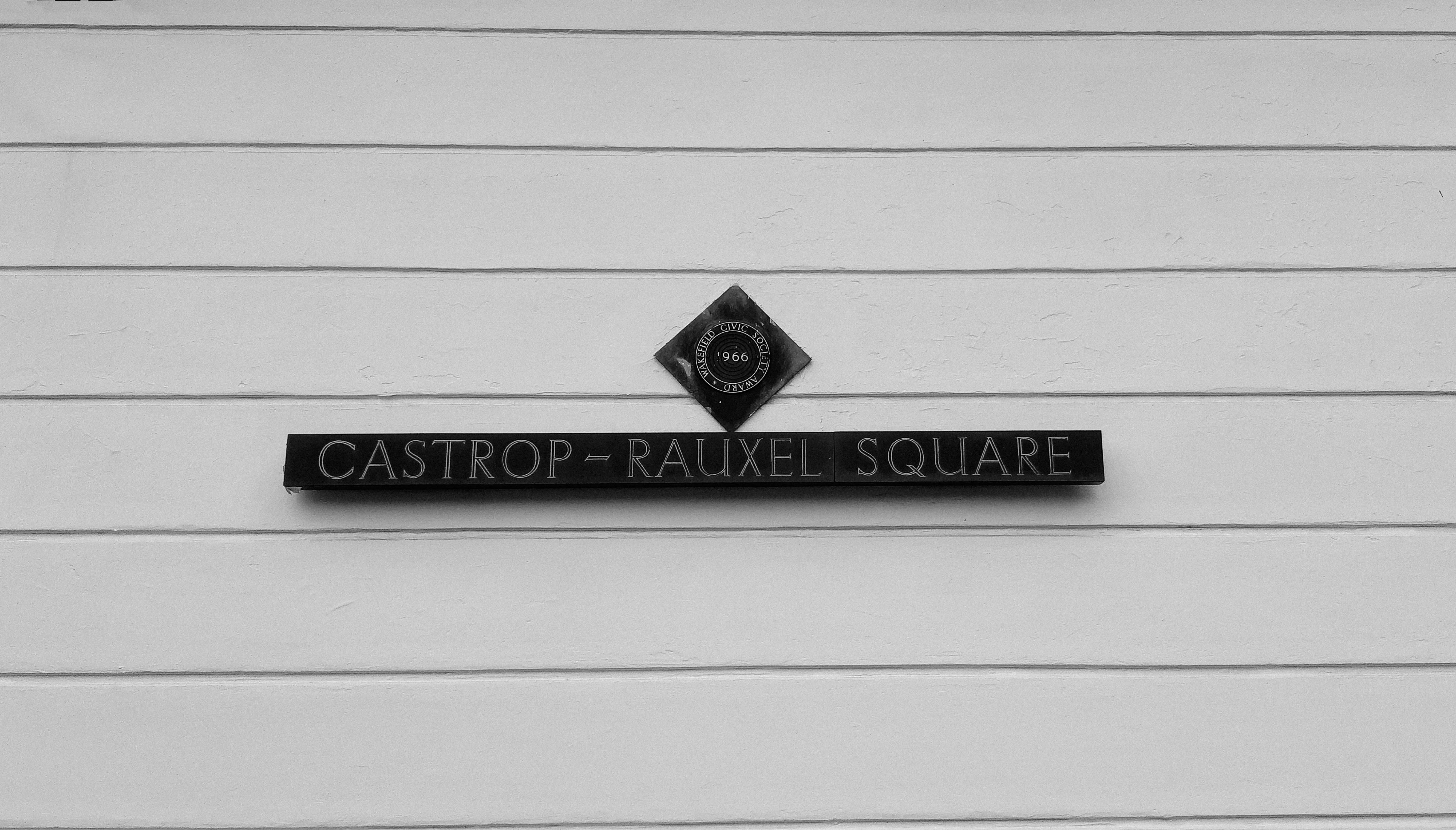 a black and white photo of a sign on a building