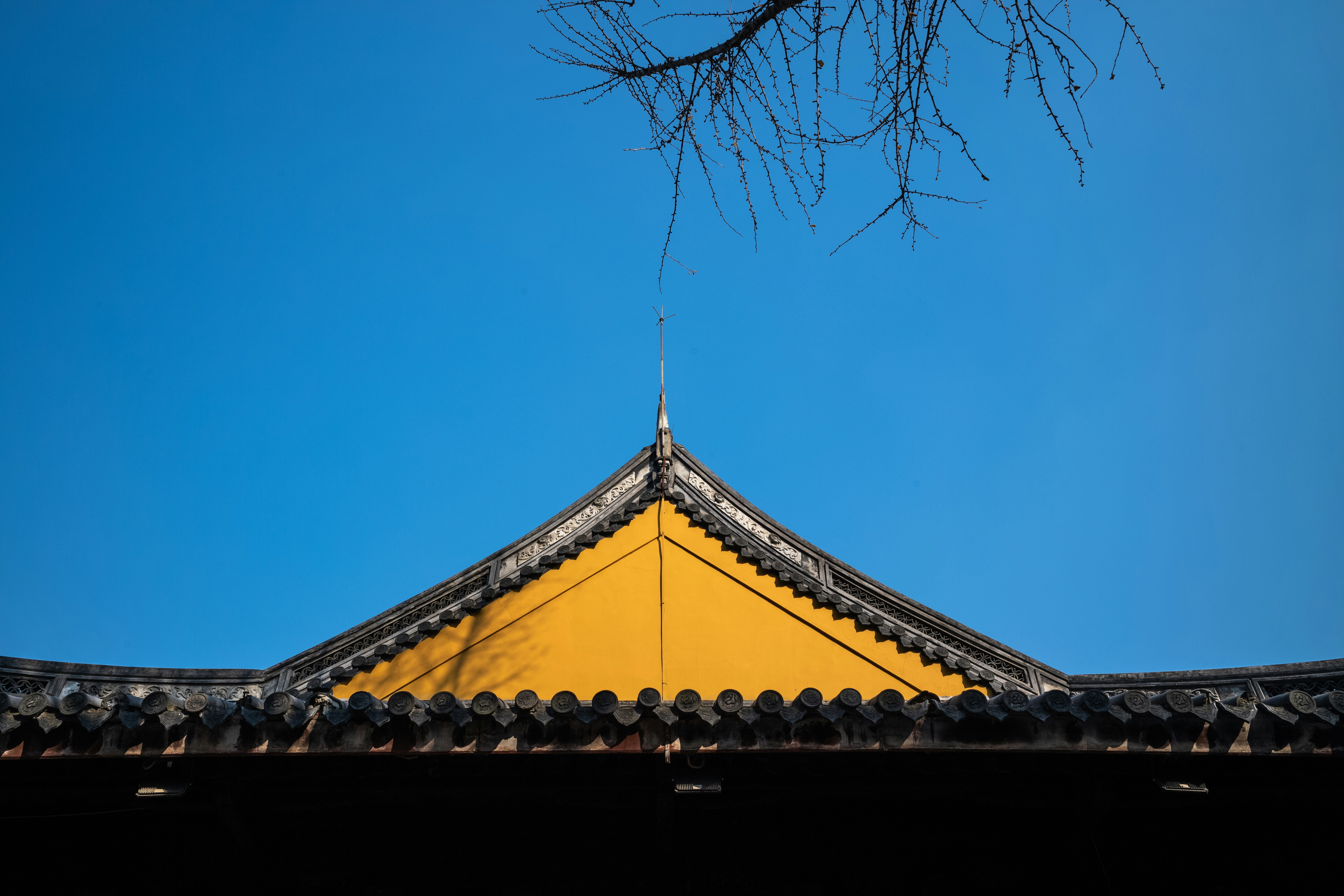 the roof of a building with a blue sky in the background