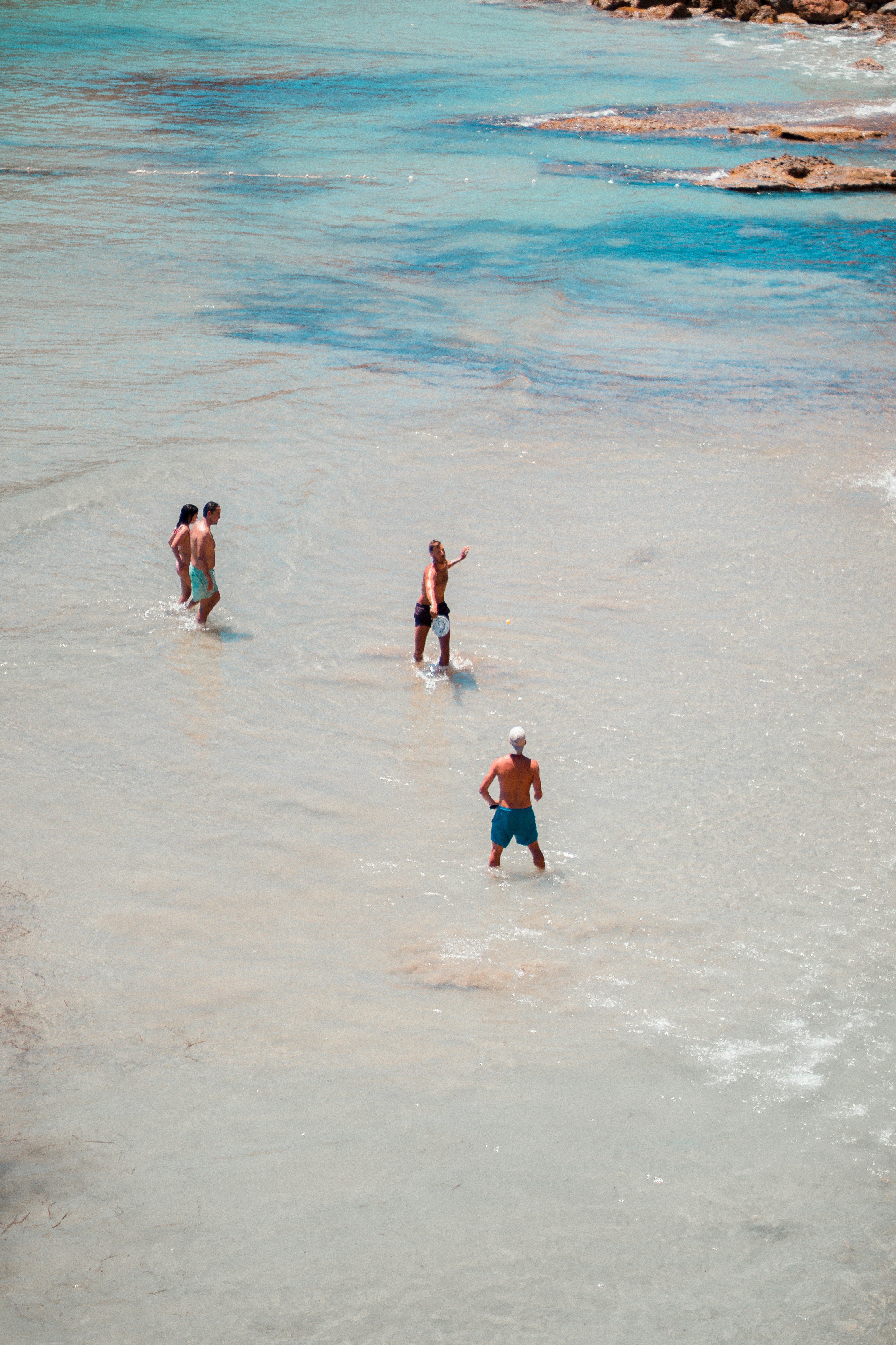 A group of people wading in shallow water photo – Free Sea Image on ...