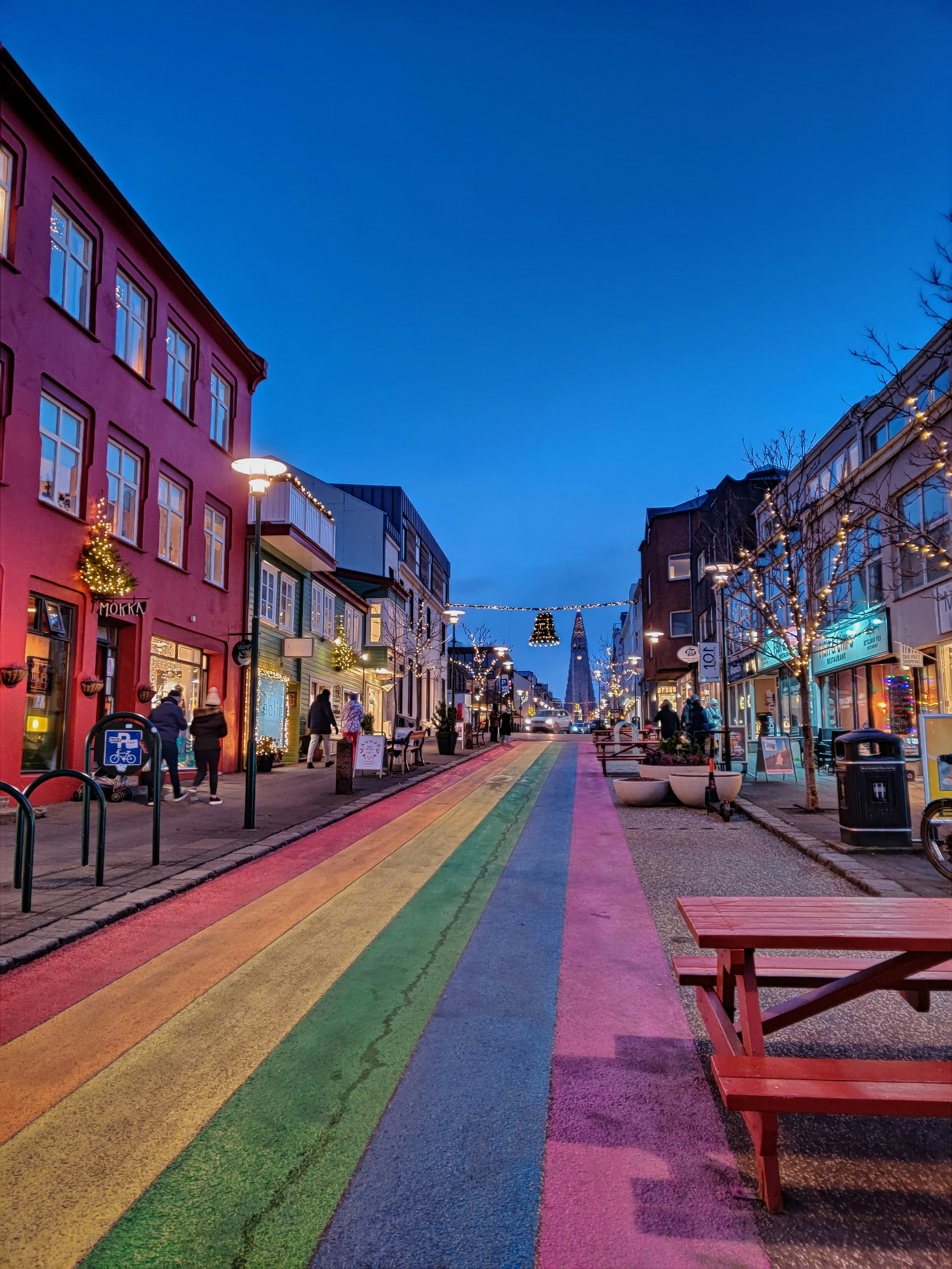 Rainbow Lane at Dusk: Twilight Commerce on a Painted Street