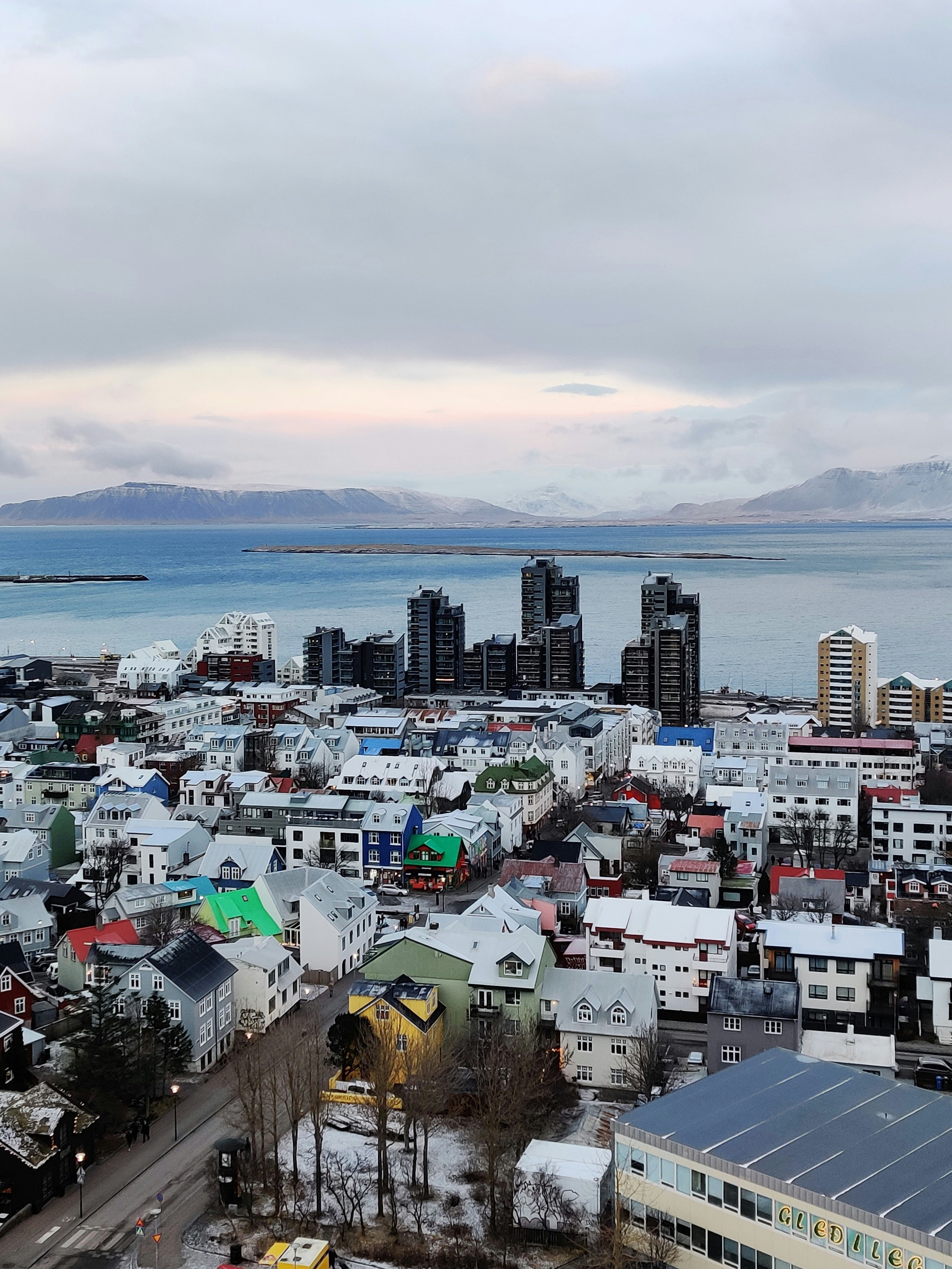 a view of a city with a body of water in the background