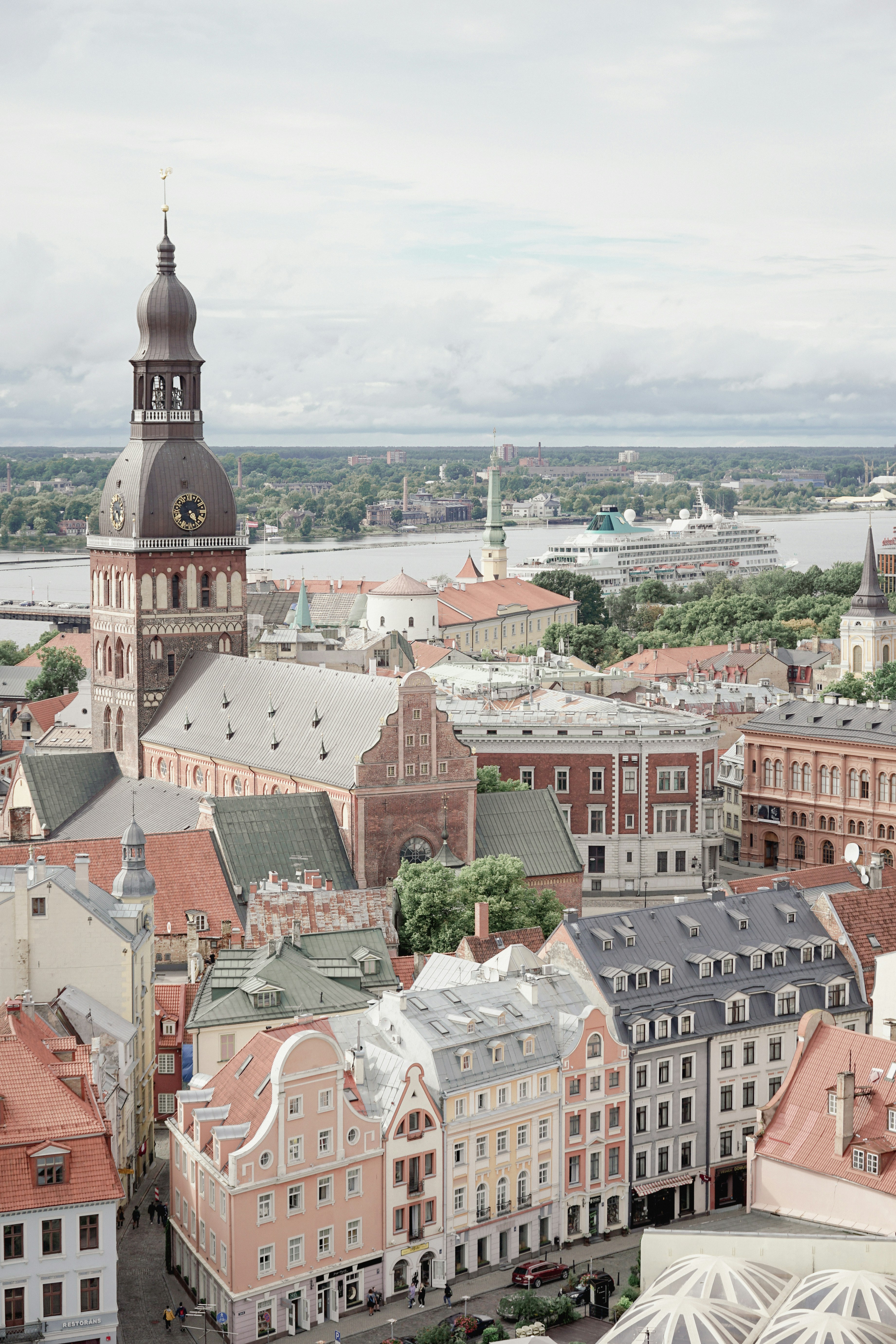 Historic buildings and rooftops of Riga, showcasing a blend of architectural styles under a cloudy sky.