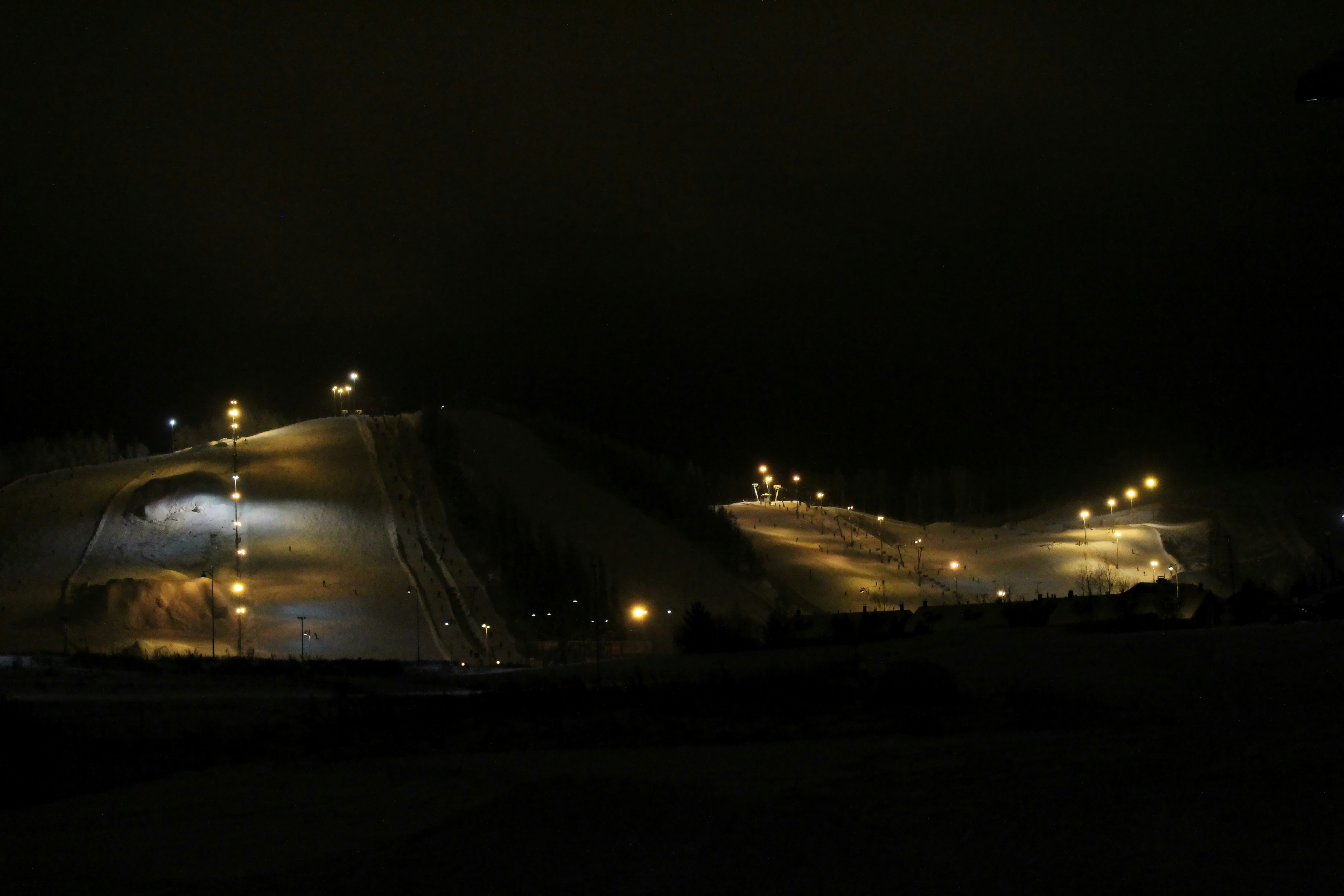 A ski slope lit up at night with lights photo – Free Outdoors Image on ...