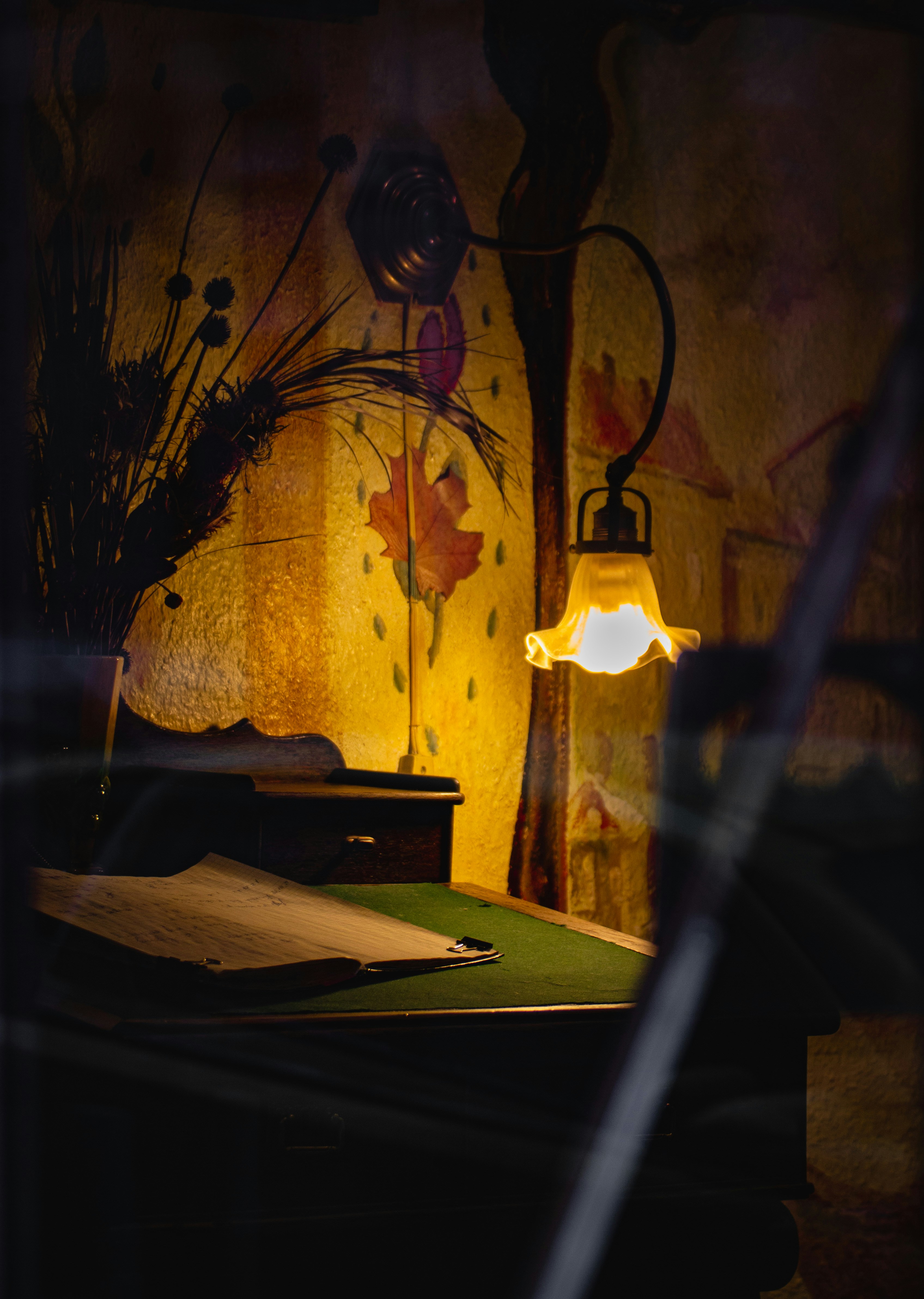 Warm Lamp, Quiet Desk: A Night Study Framed by Floral Wall Art