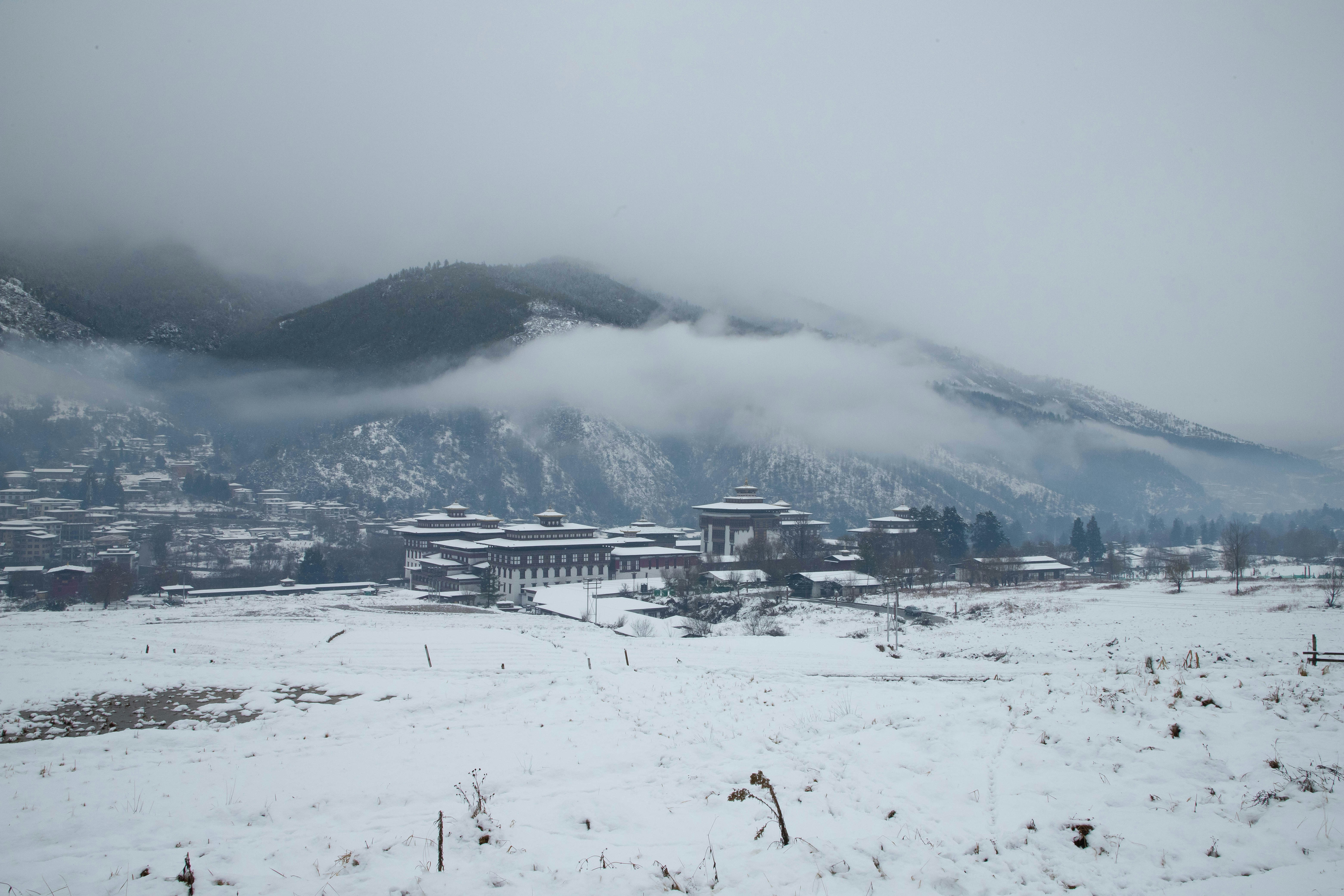 Snowbound Village Beneath Shrouded Peaks