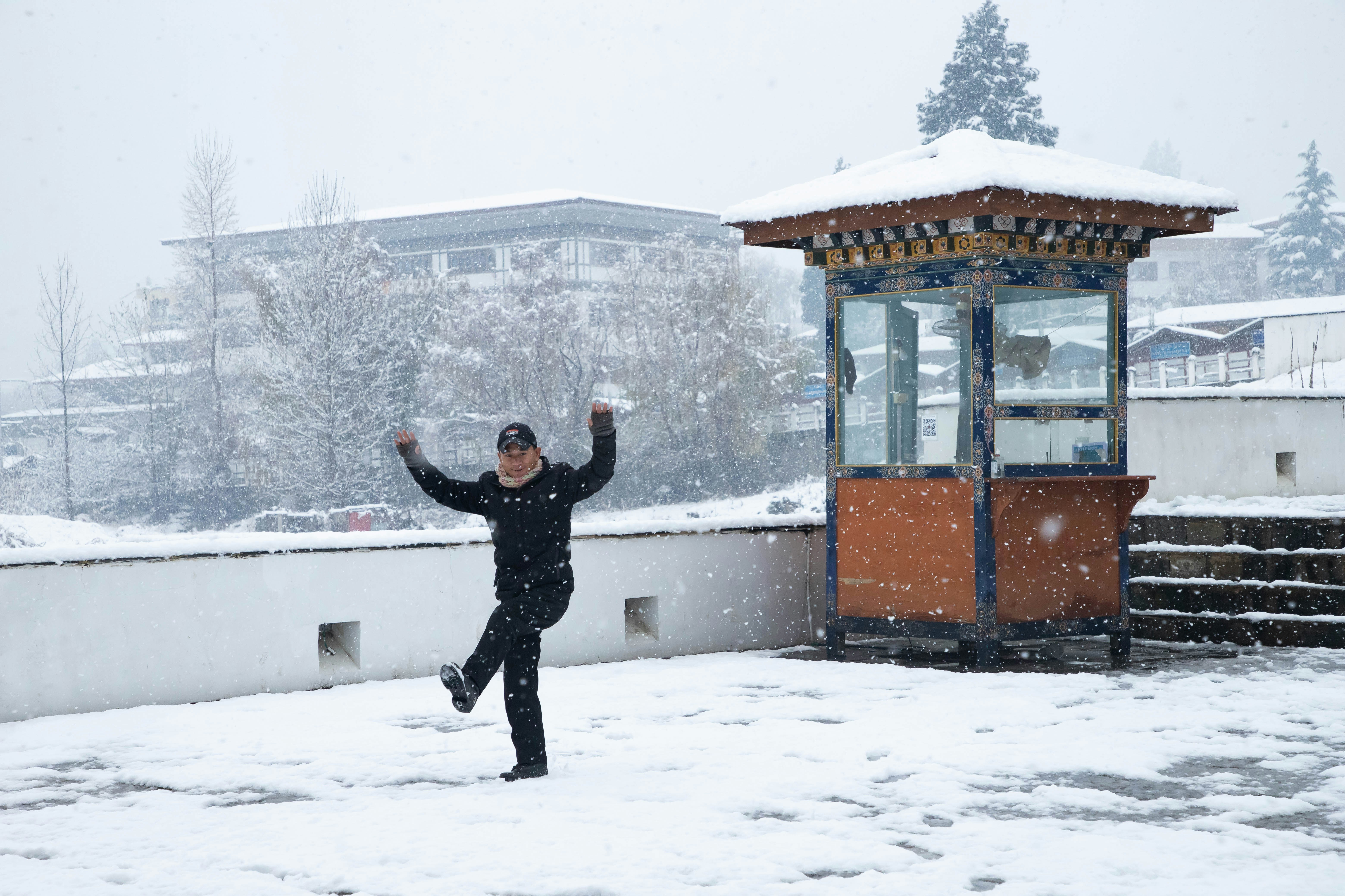 Winter Leap by the Guardhouse: A Snow-Blanketed Courtyard Moment
