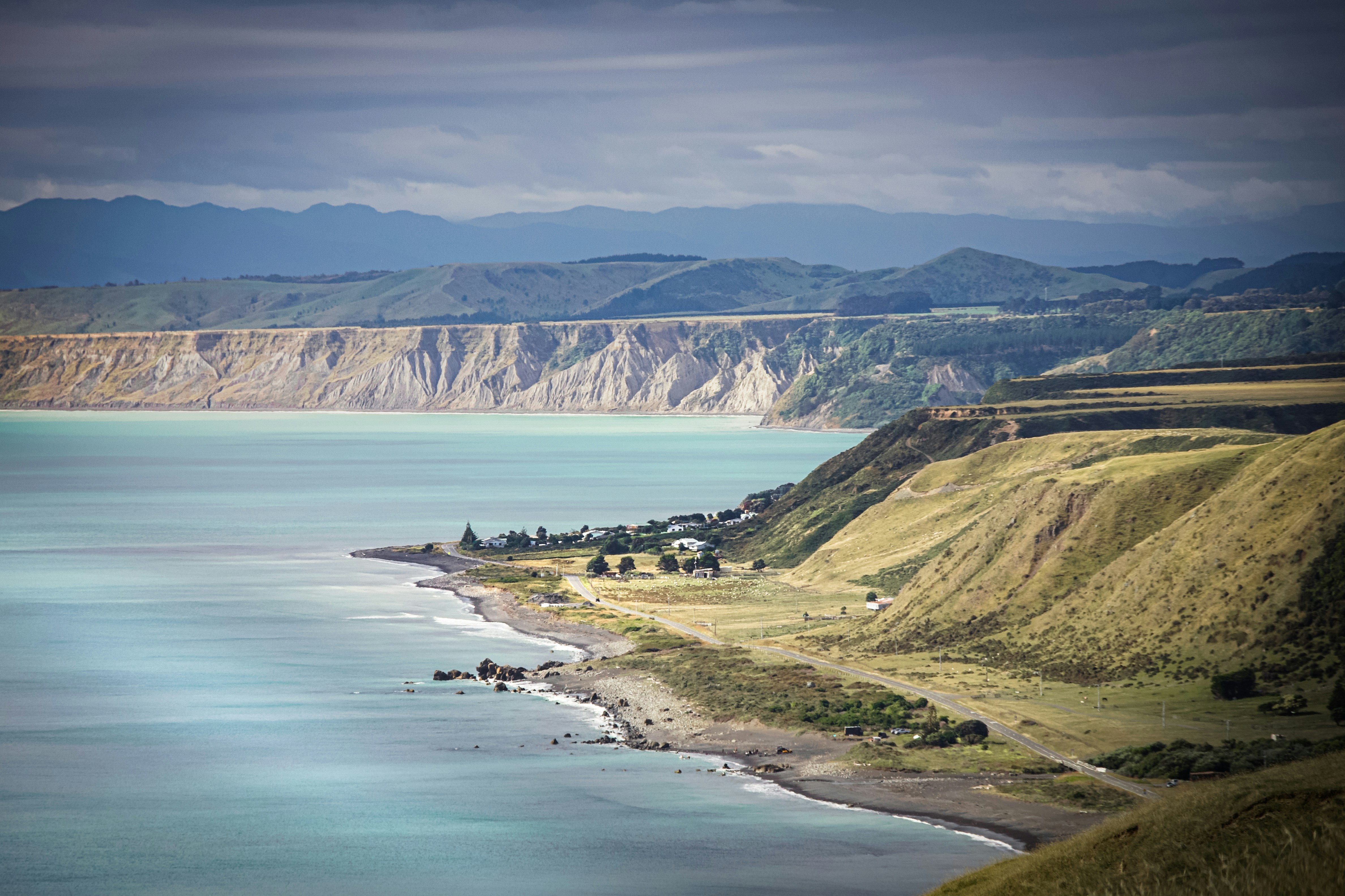 Verdant Cliffs and Turquoise Bay: A Quiet Coastal Panorama