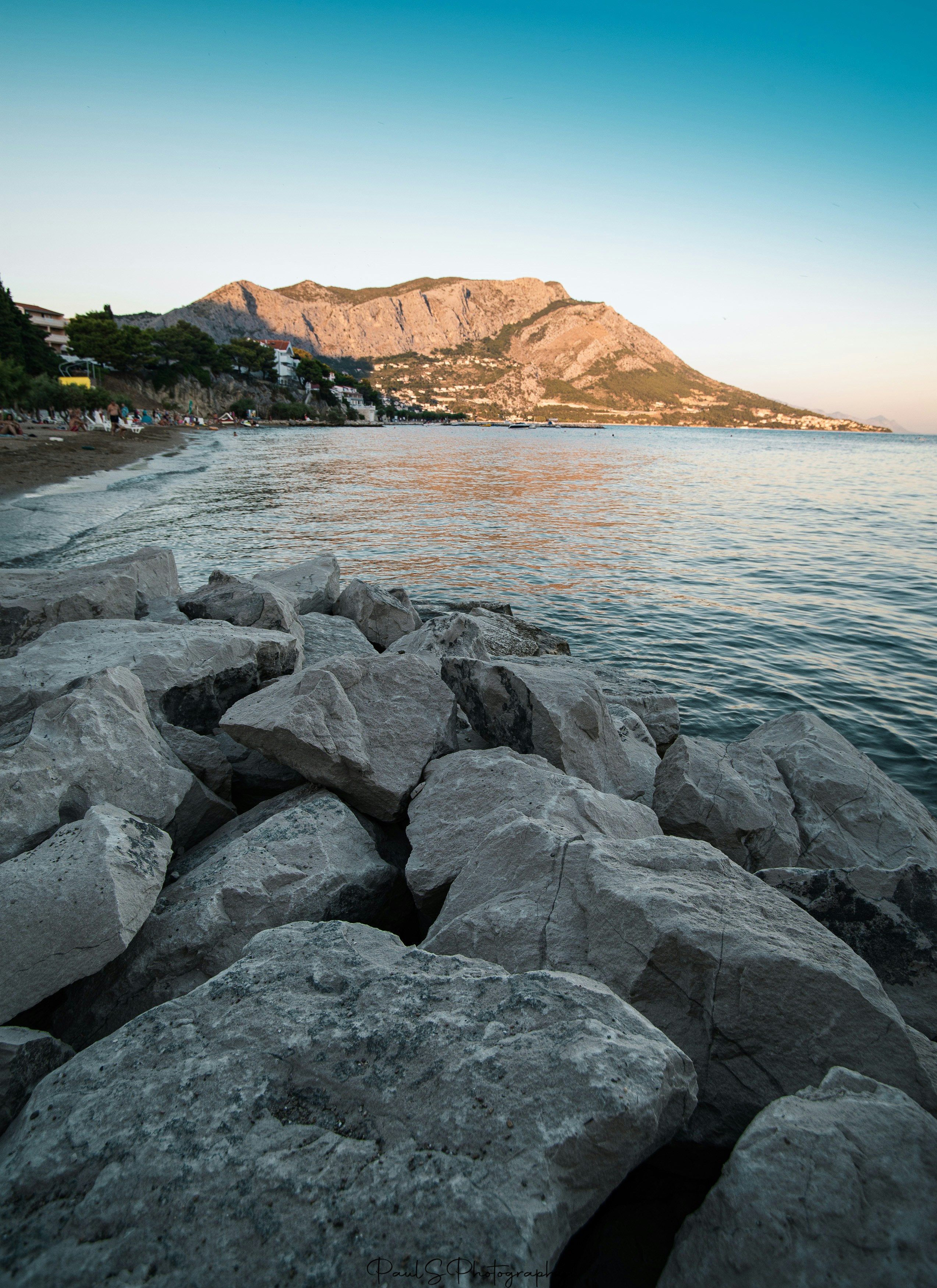 A rocky shore with a mountain in the background photo – Free Croatia ...