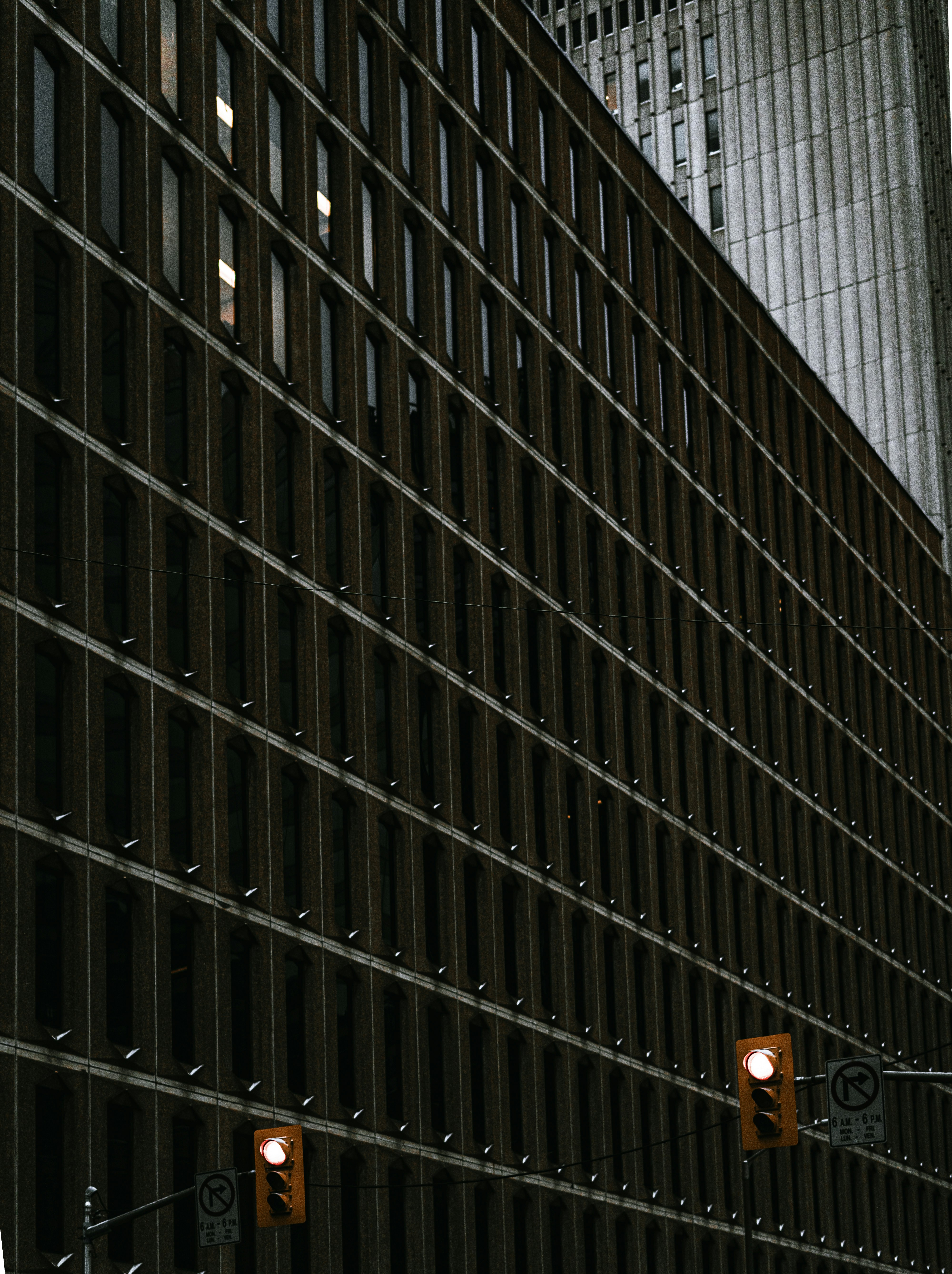 Diagonal Grid of Steel: Amber Signals at the Facade's Edge