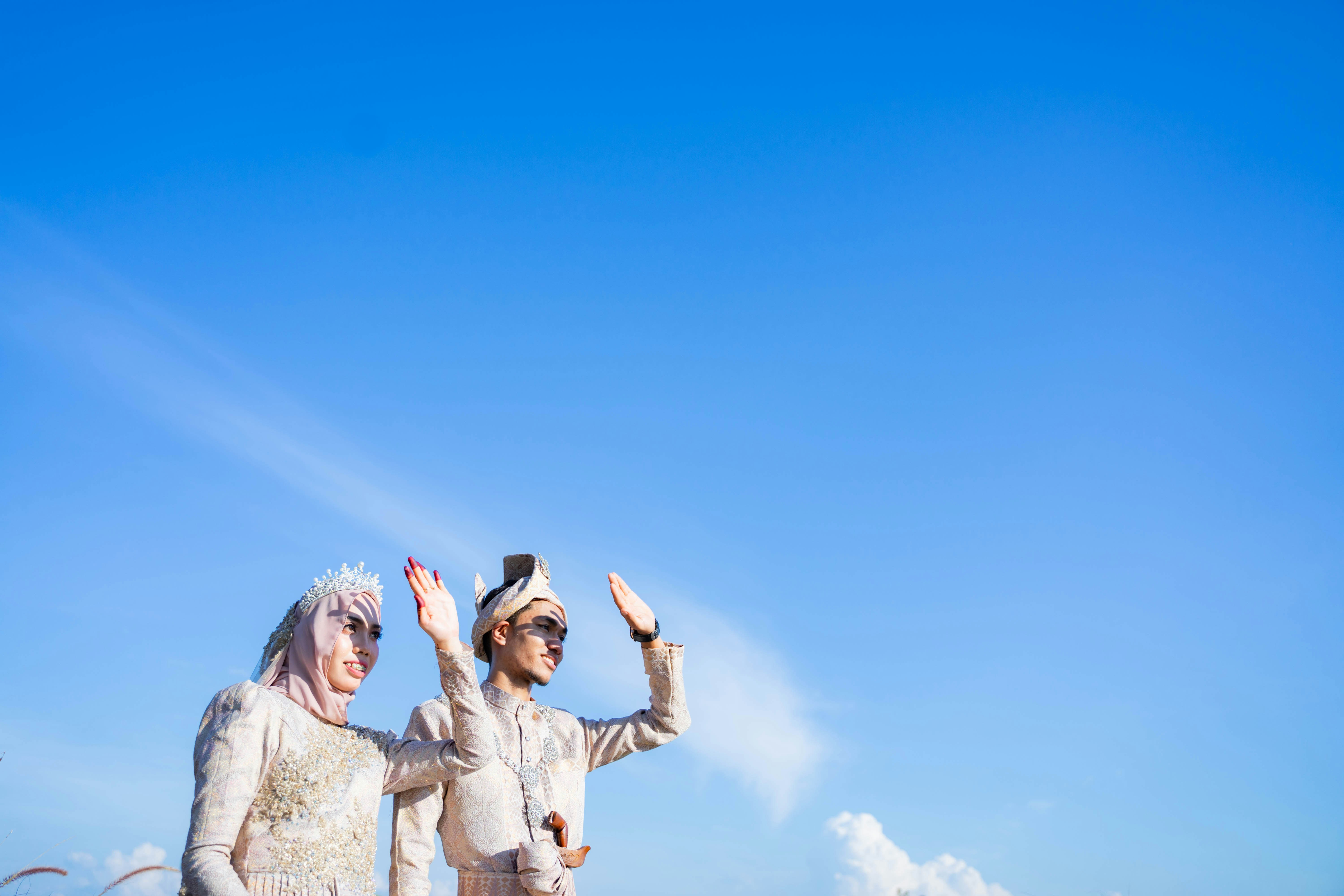 Raising Horizons: Two White-Cloaked Figures in a Sunlit Parade