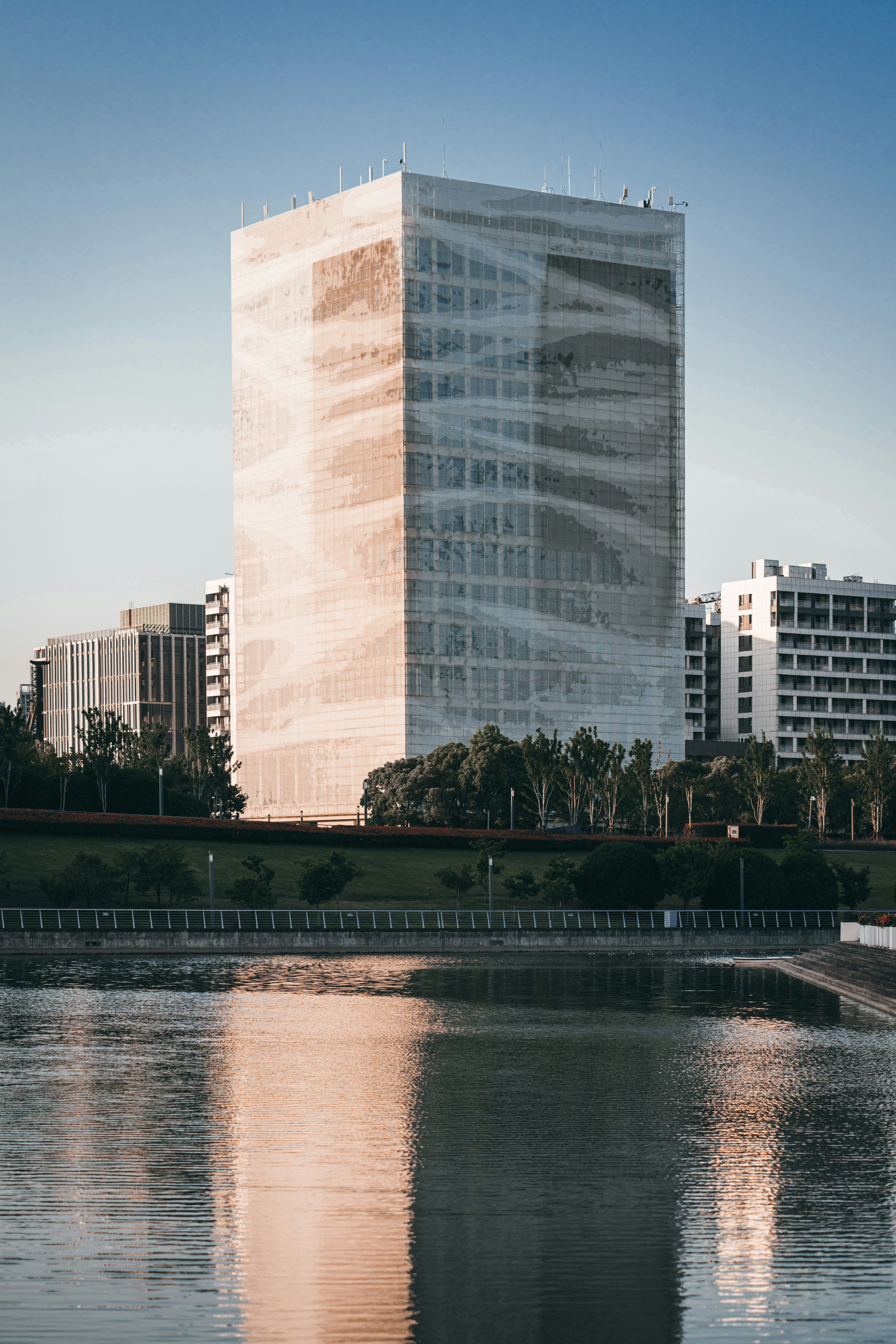 a tall building sitting next to a body of water