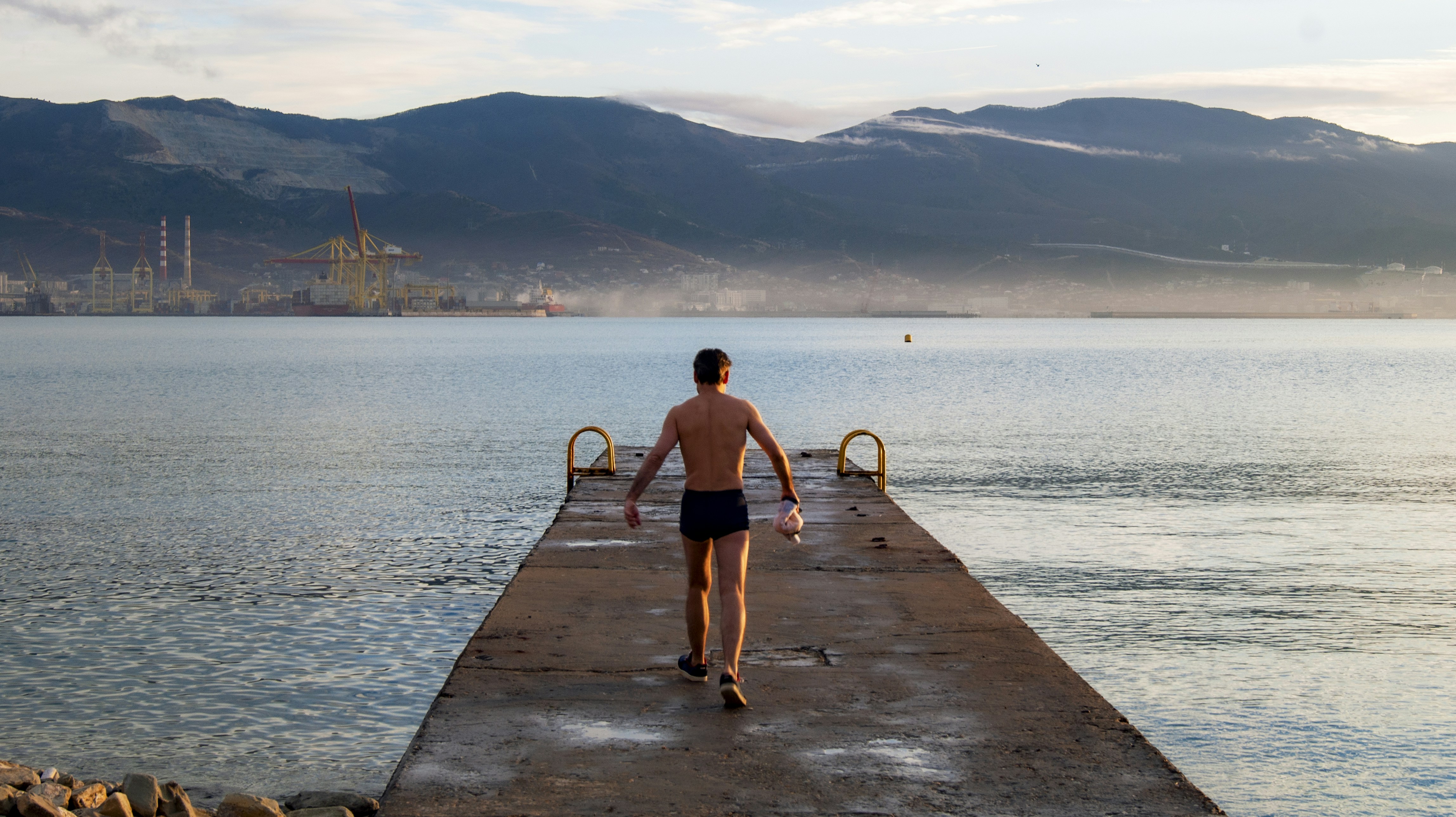 Alone at the Pier: A Stroll Toward the Quiet Horizon