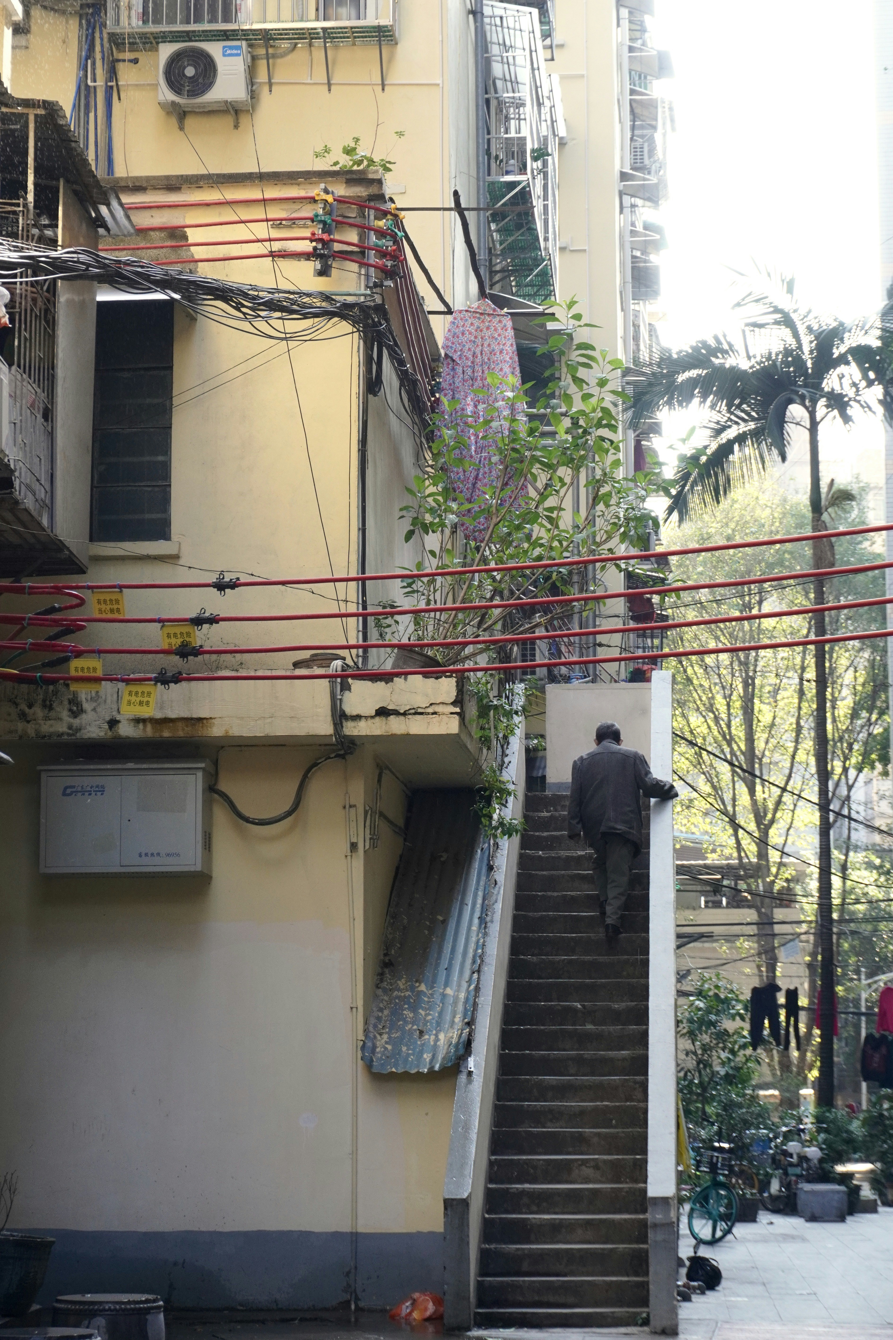 Urban Ascent: Suit-Clad Figure Climbing the Sunlit Stairwell