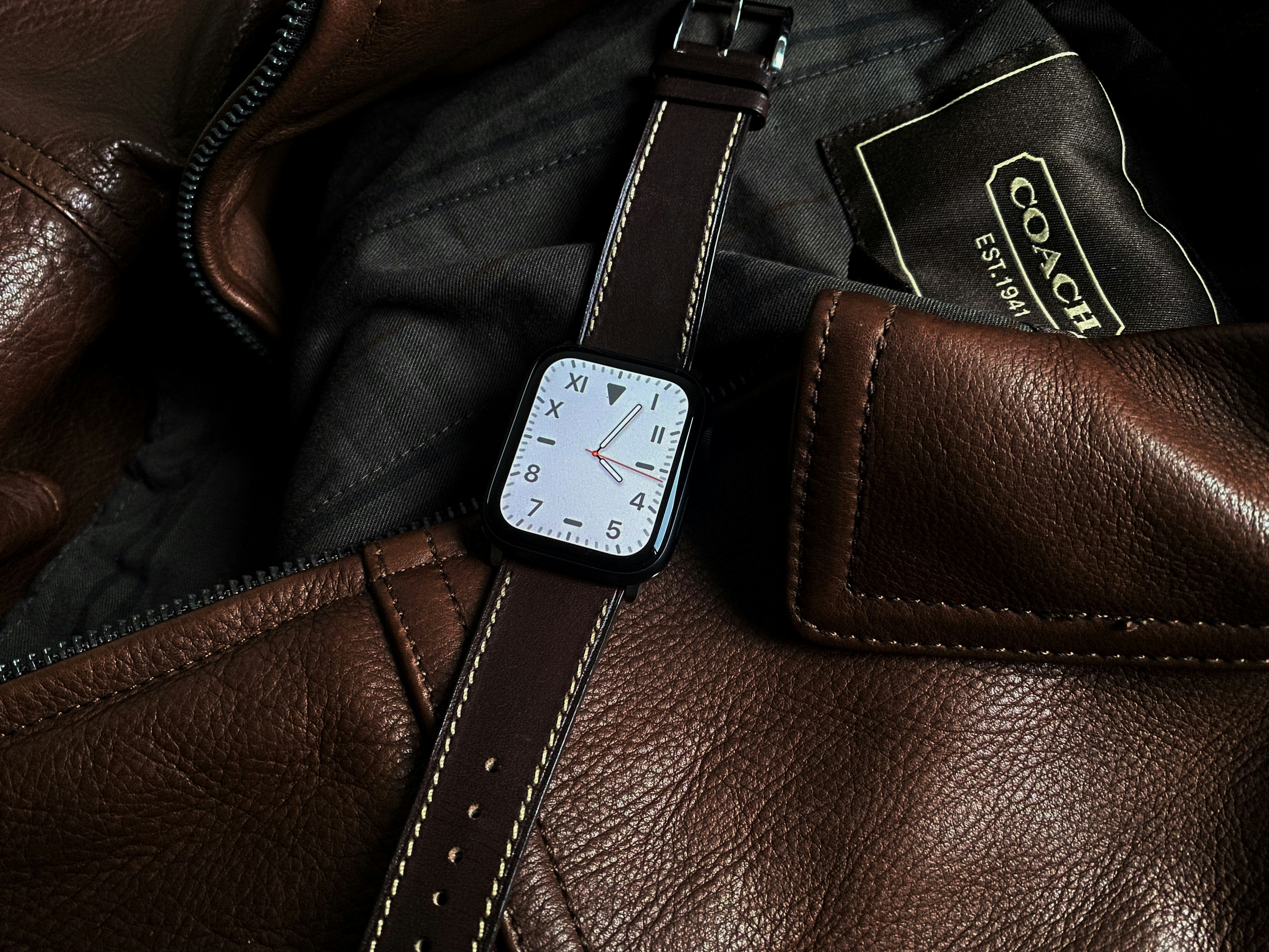 A close up of a watch on a leather bag photo – Free Jacket Image on ...