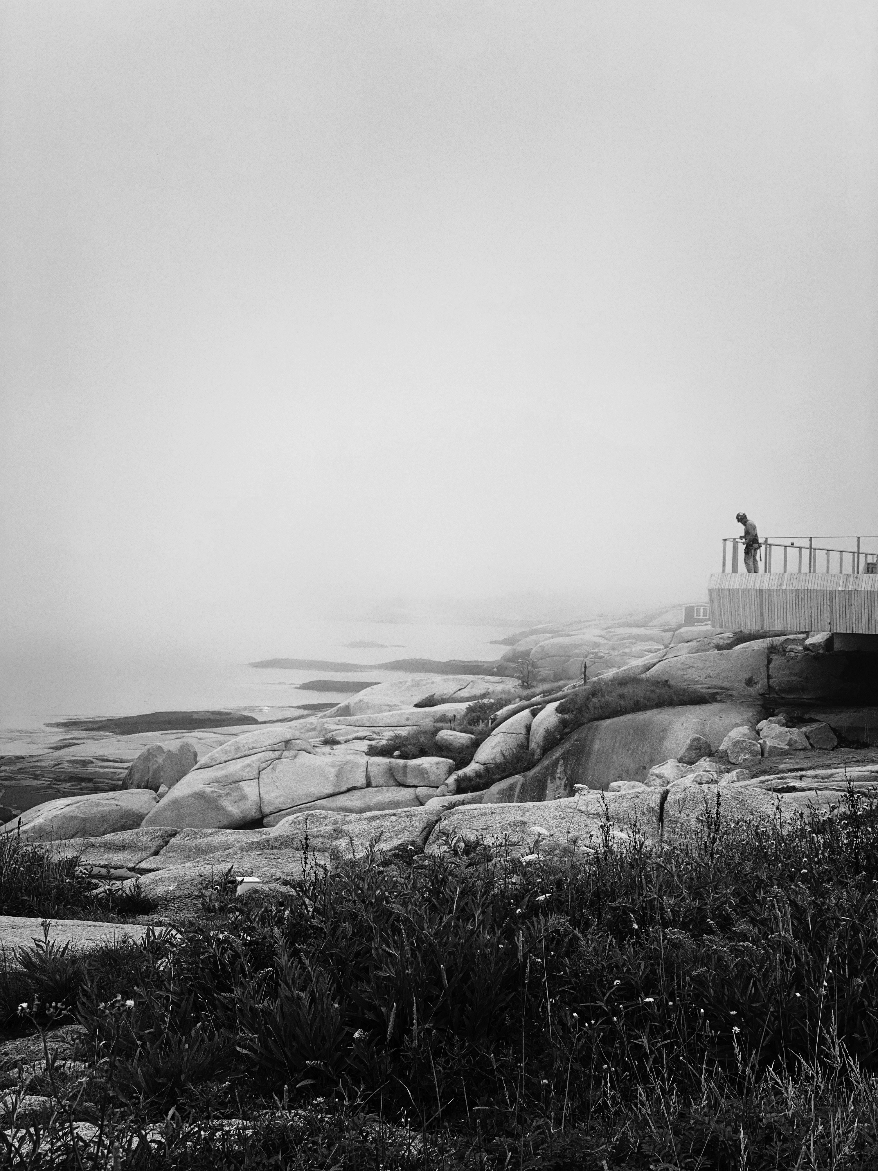 a couple of people standing on top of a cliff