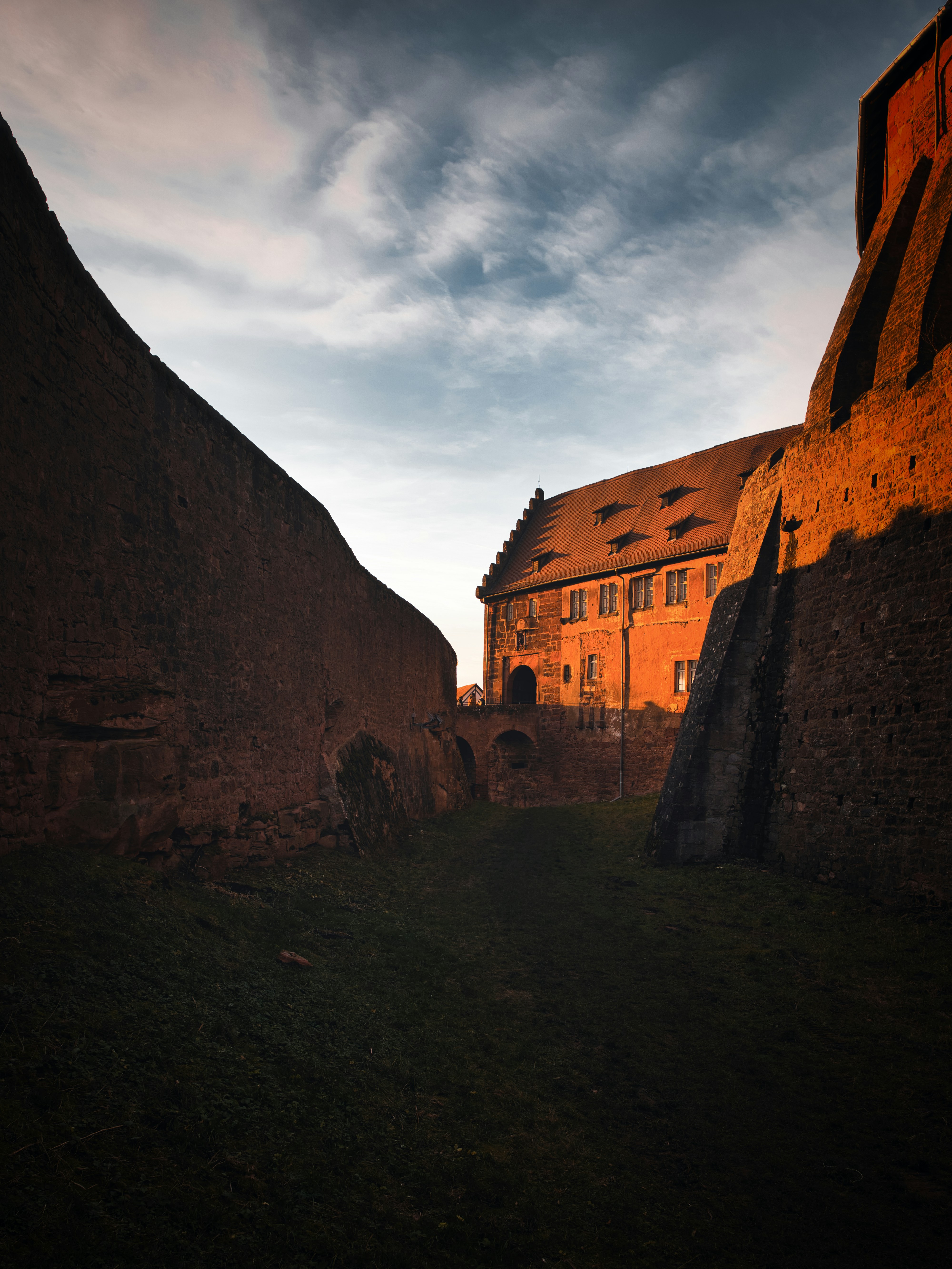 a dark alley way with a building in the background