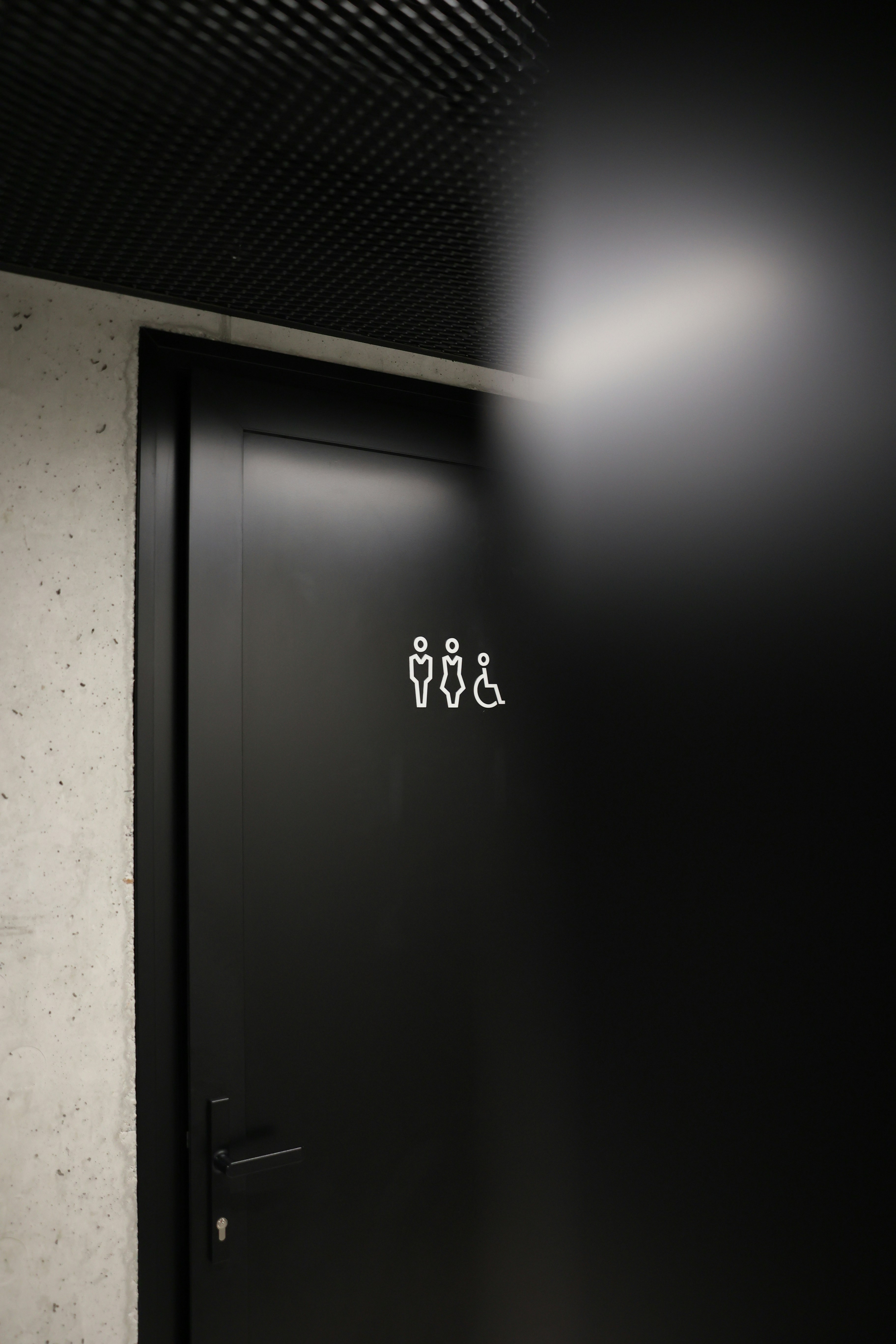 a black door with a white sticker on it