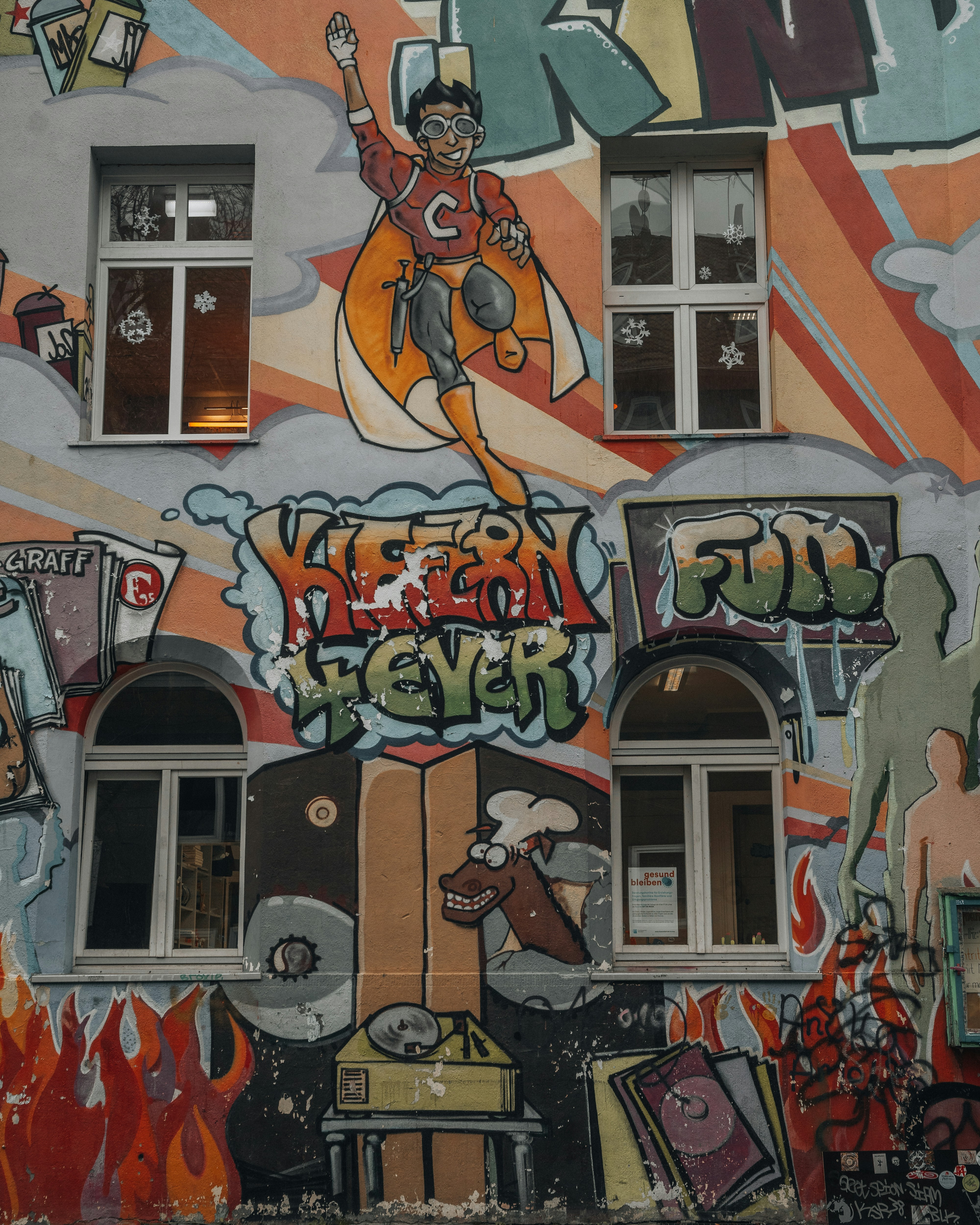 Runner in Red Leaps Across a Wall of Colorful Graffiti