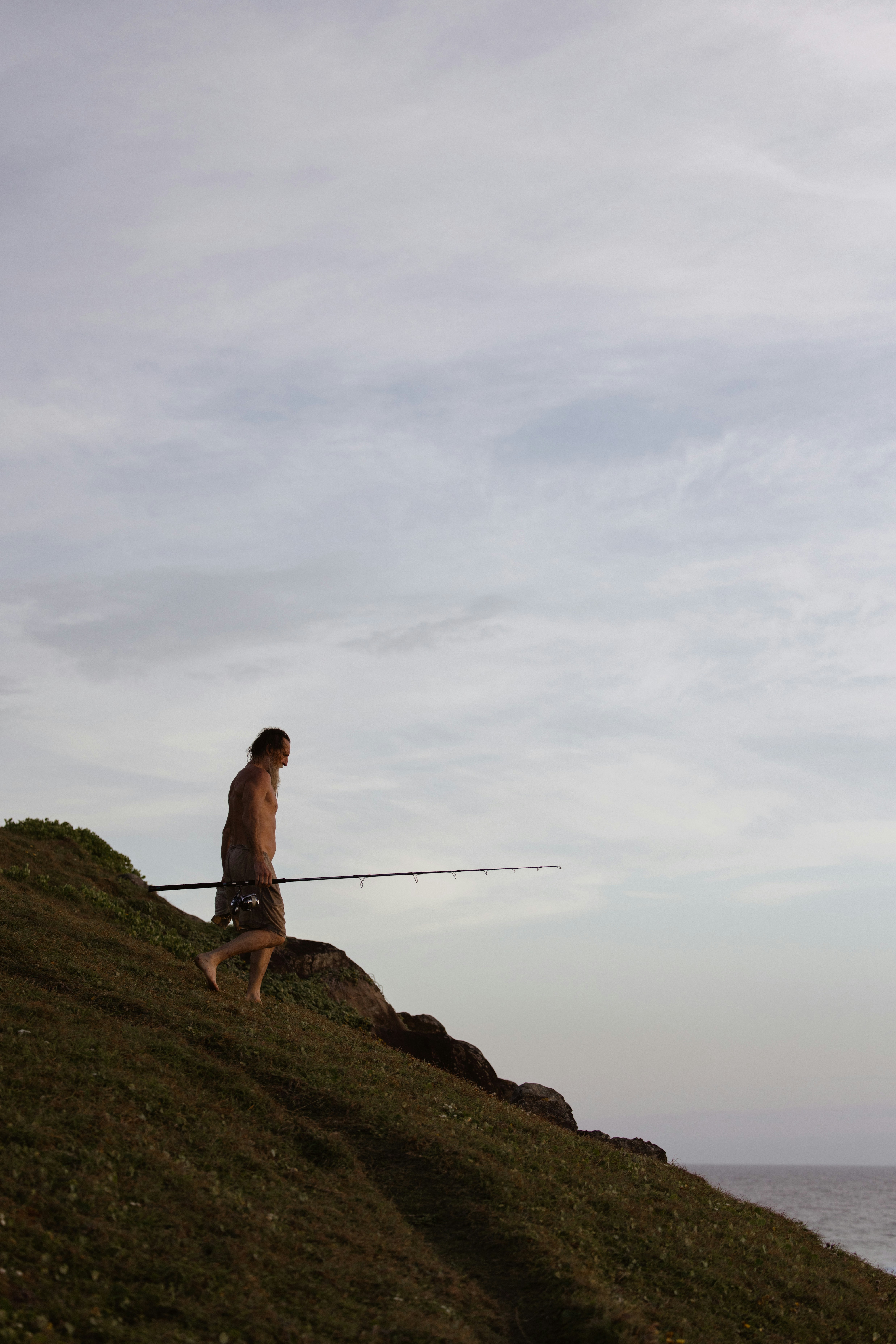 Lone Angler on a Cliff's Edge