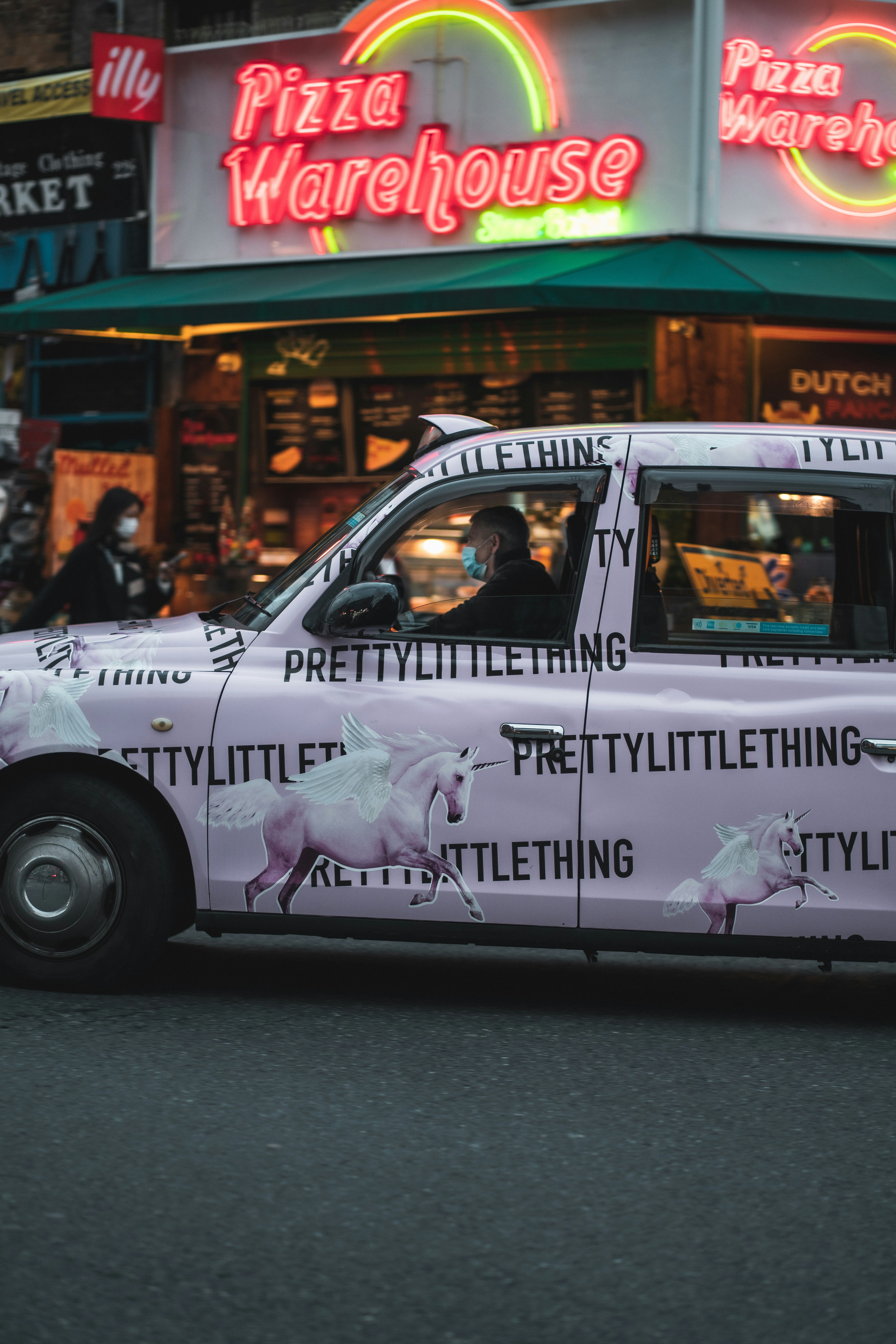 A white taxi cab with a pink flower painted on it's side photo – Free ...
