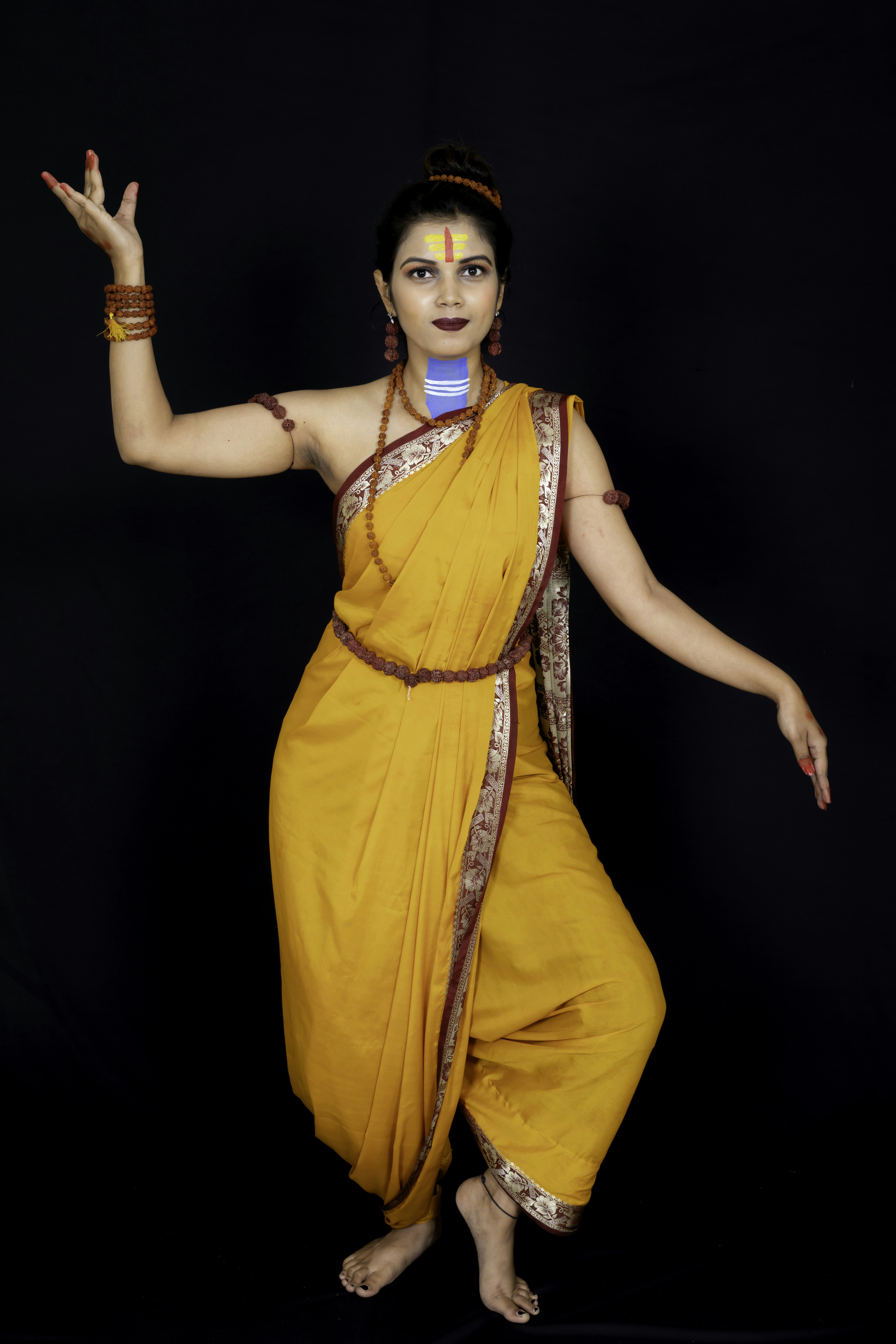 A woman in a yellow sari dancing photo – Free Clothing Image on Unsplash