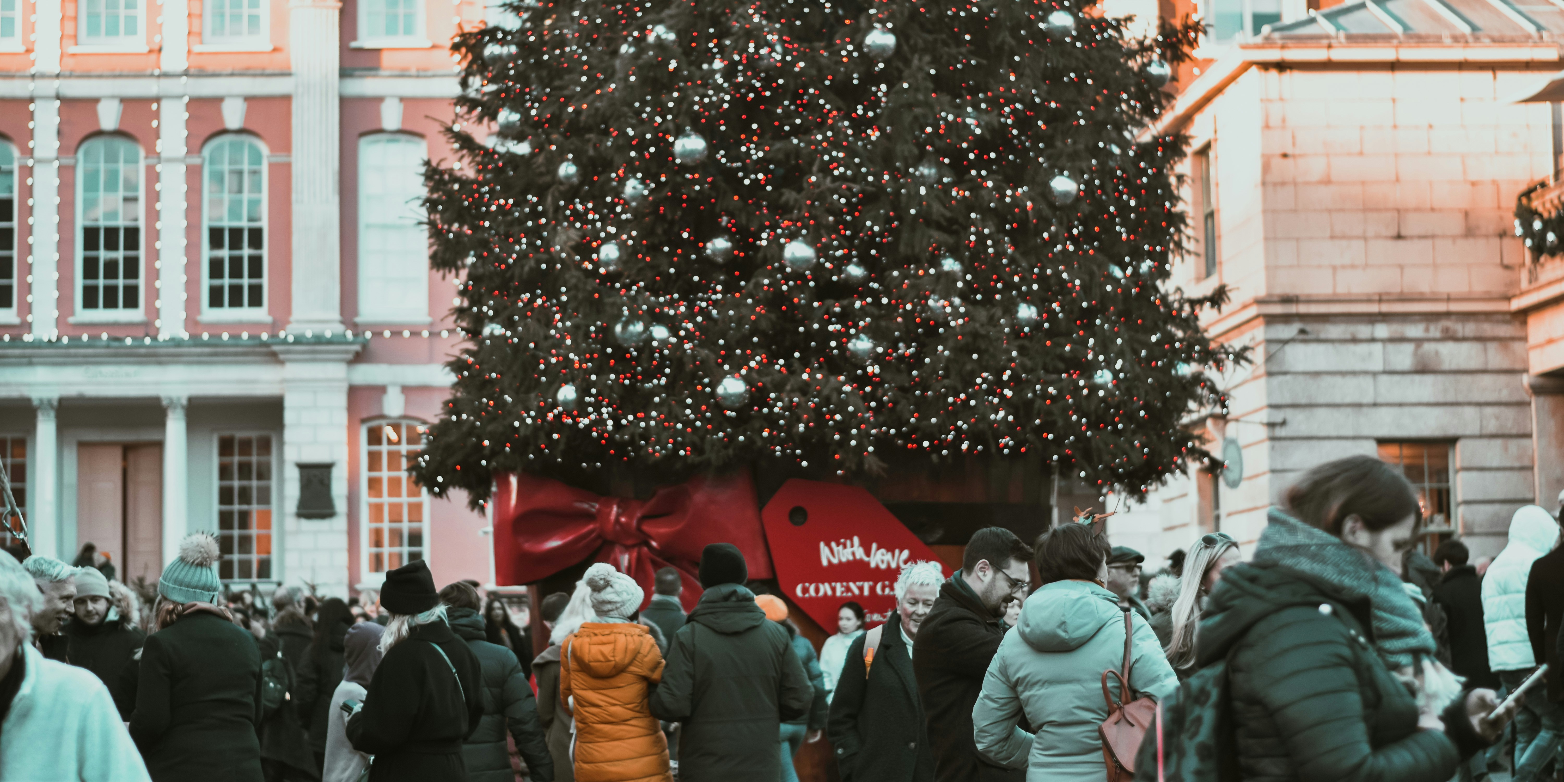 A large christmas tree in the middle of a crowd of people photo – Free ...