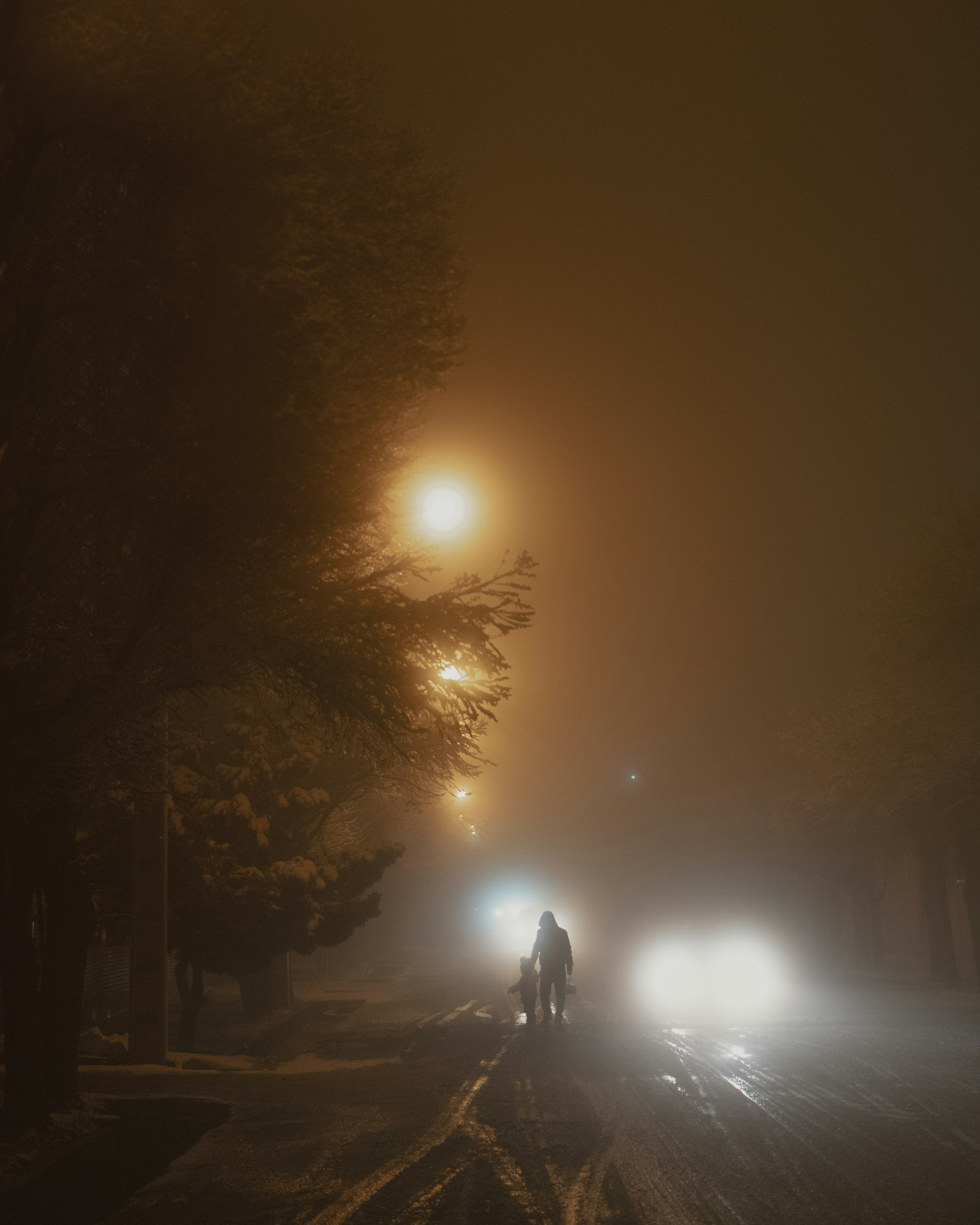 Amber Veil on a Quiet Street: Two Silhouettes in Fog