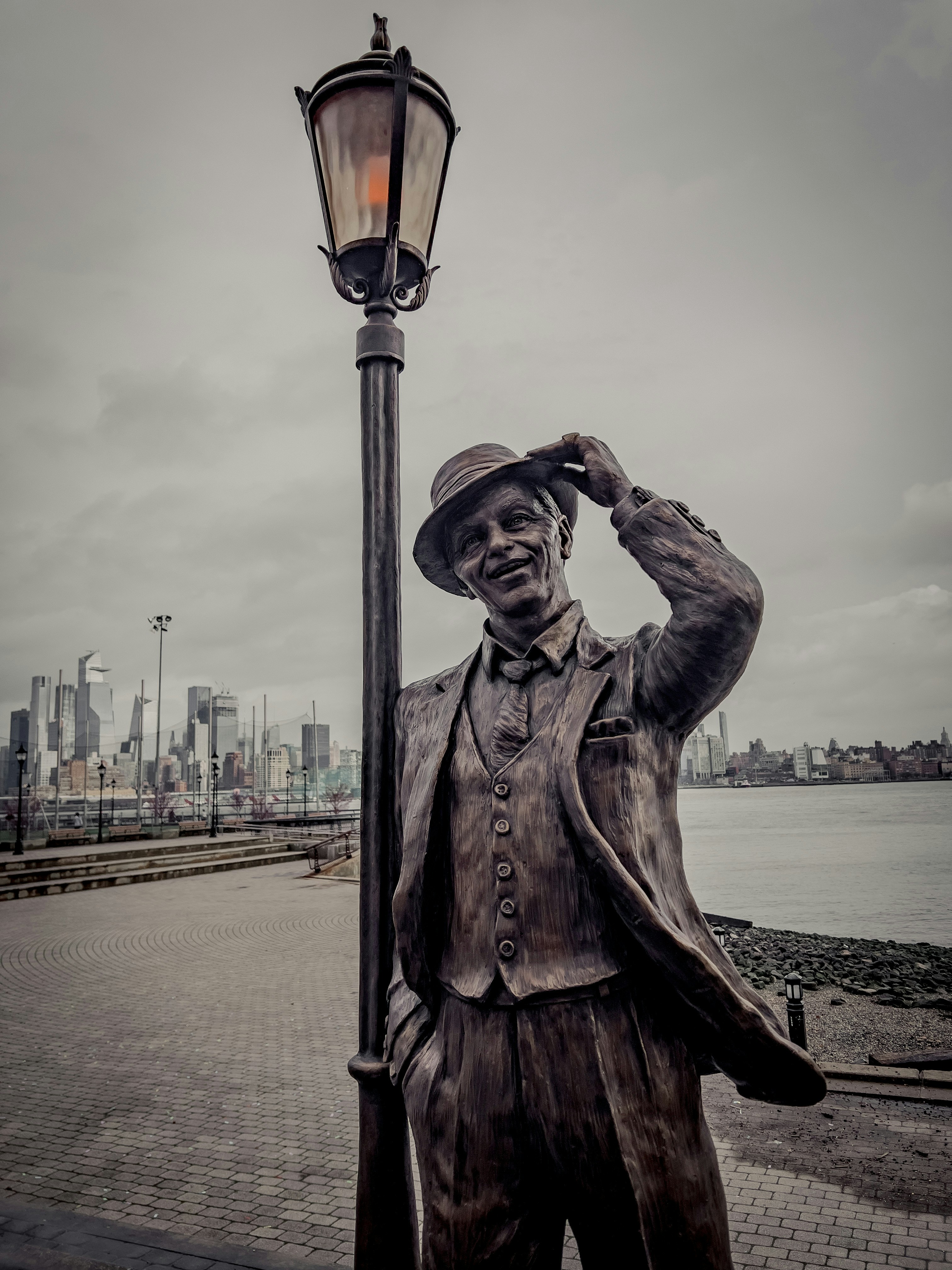 A statue of a man holding a lamp post photo – Free Art Image on Unsplash