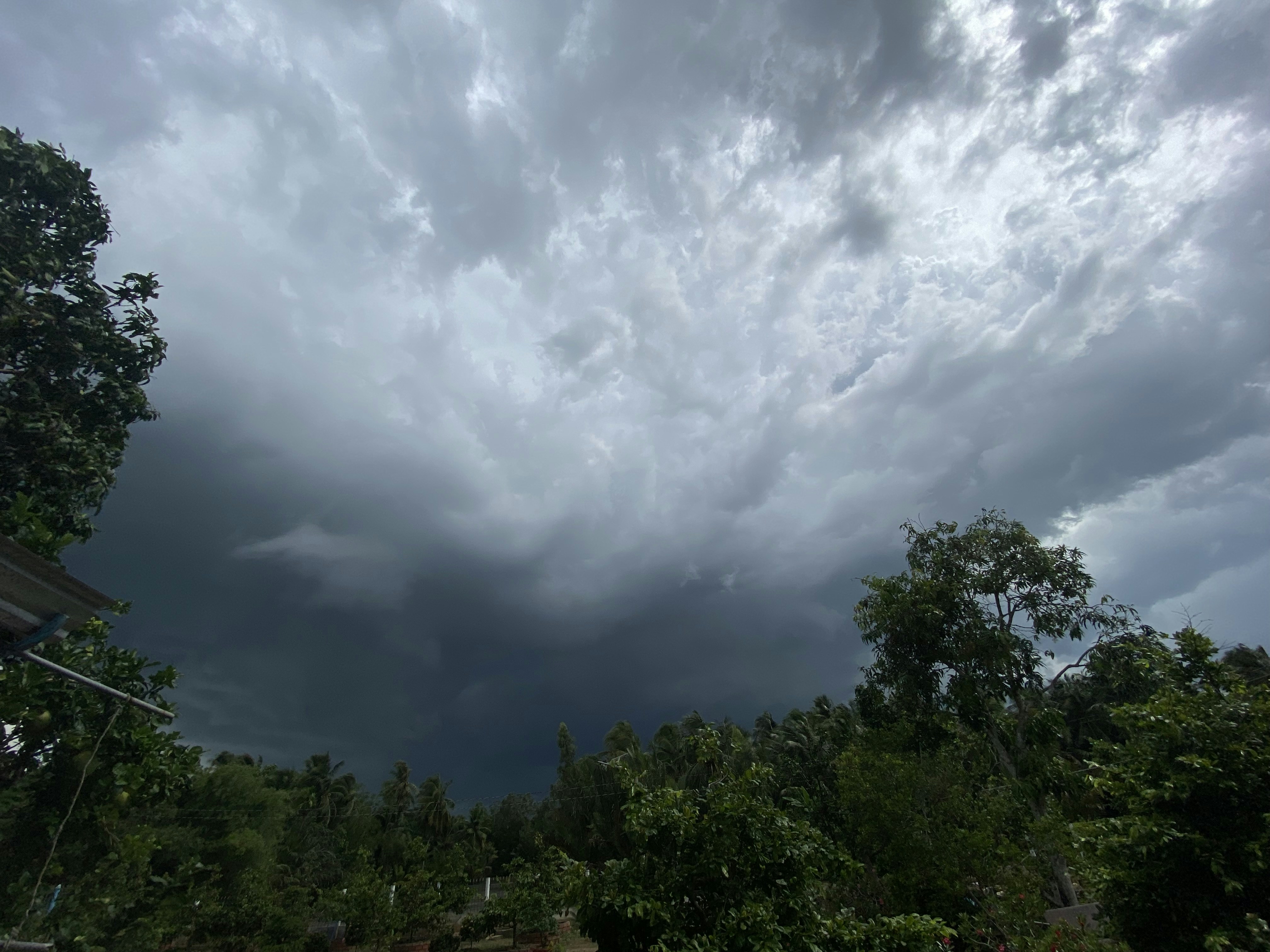 A storm moving through the sky over a forest photo – Free Vietnam Image ...