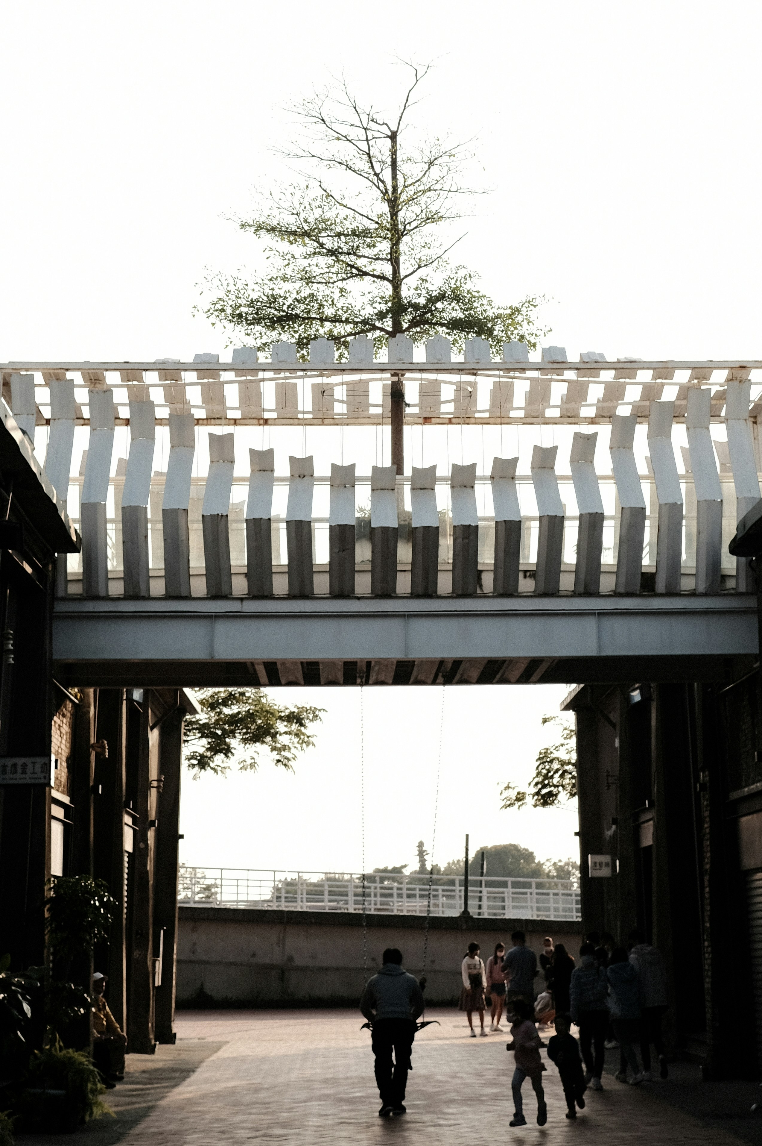 A group of people walking under a bridge photo – Free Streetphotography ...