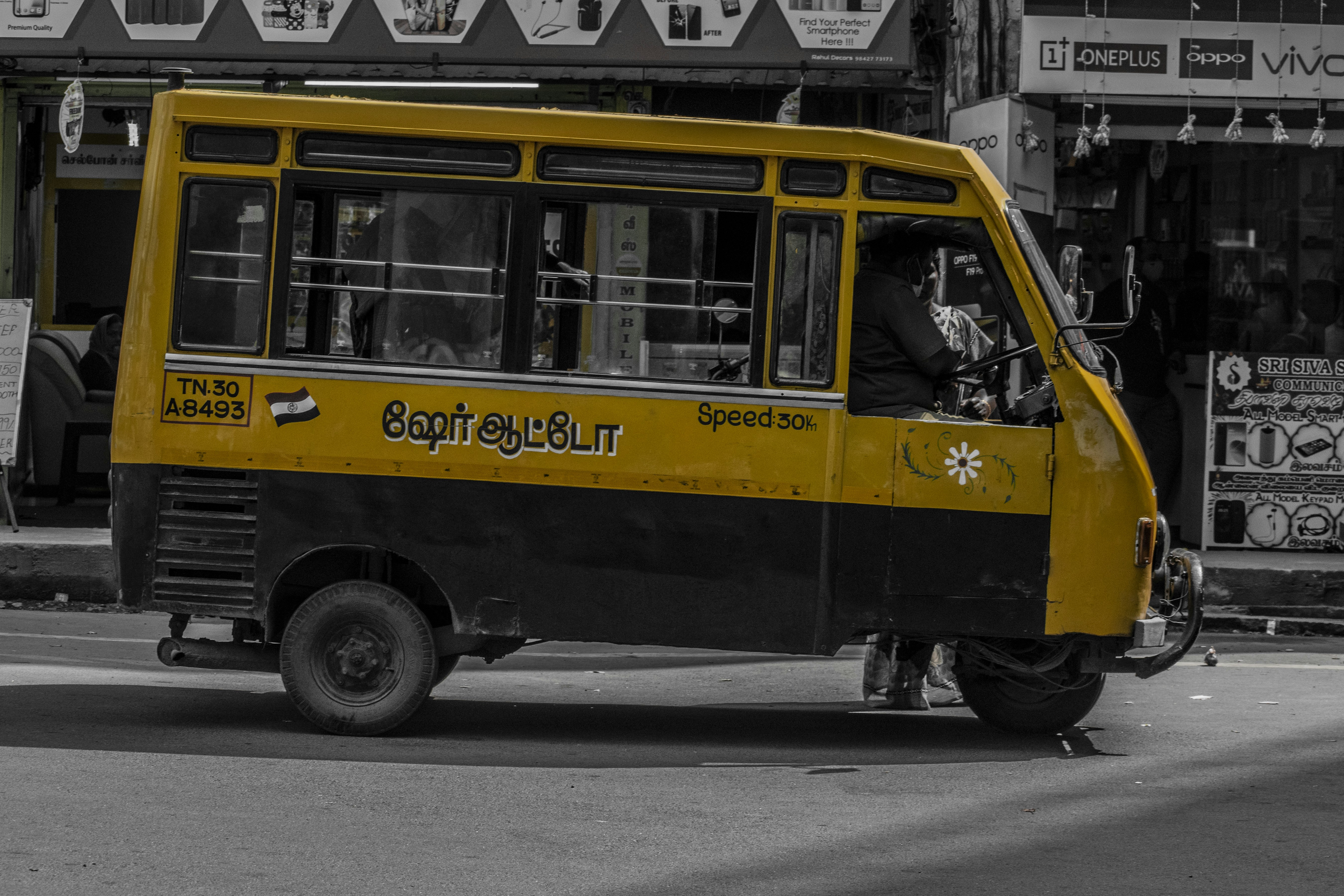 A yellow and black bus driving down a street photo – Free Salem Image ...