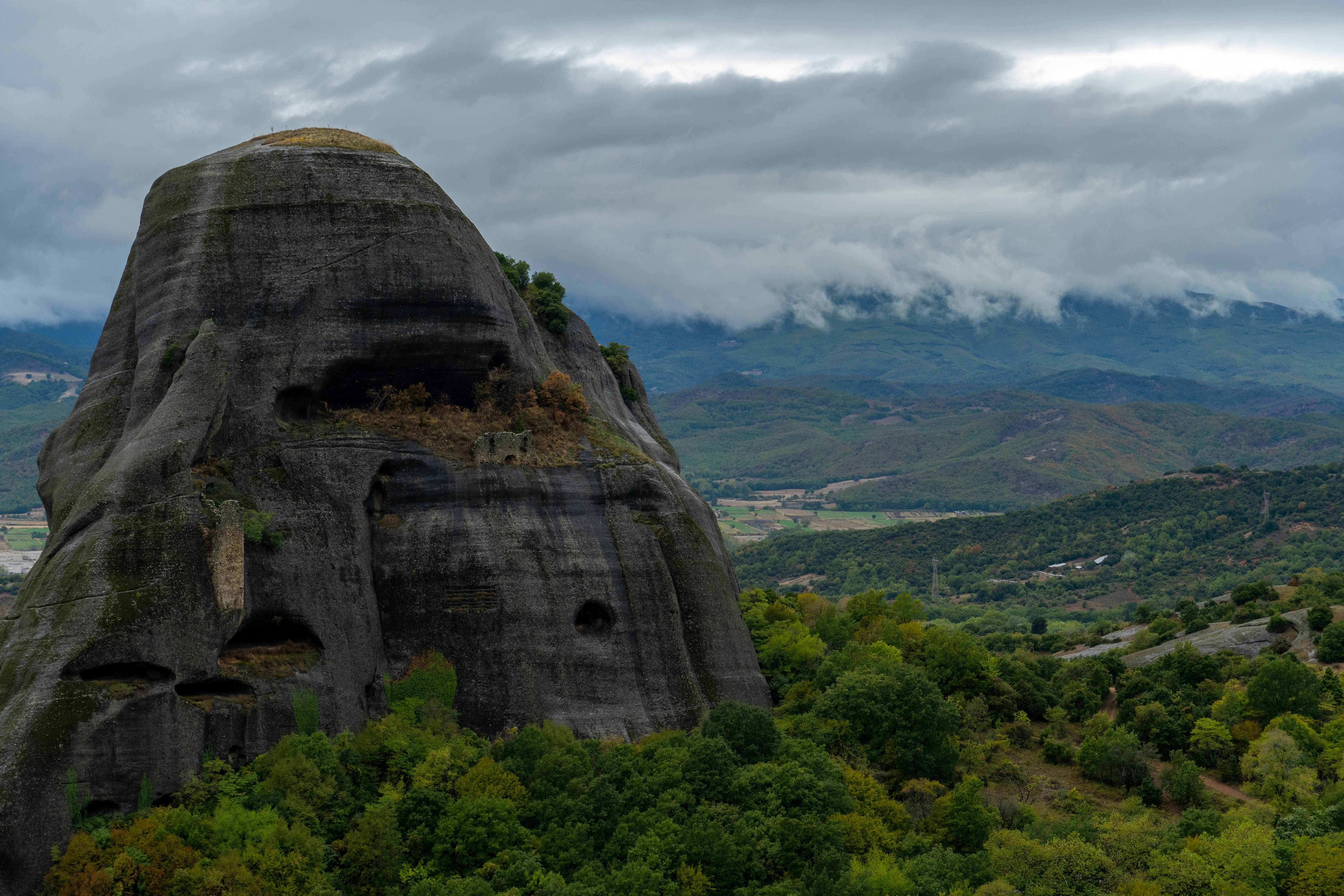 A large rock formation in the middle of a forest photo – Free Nature ...