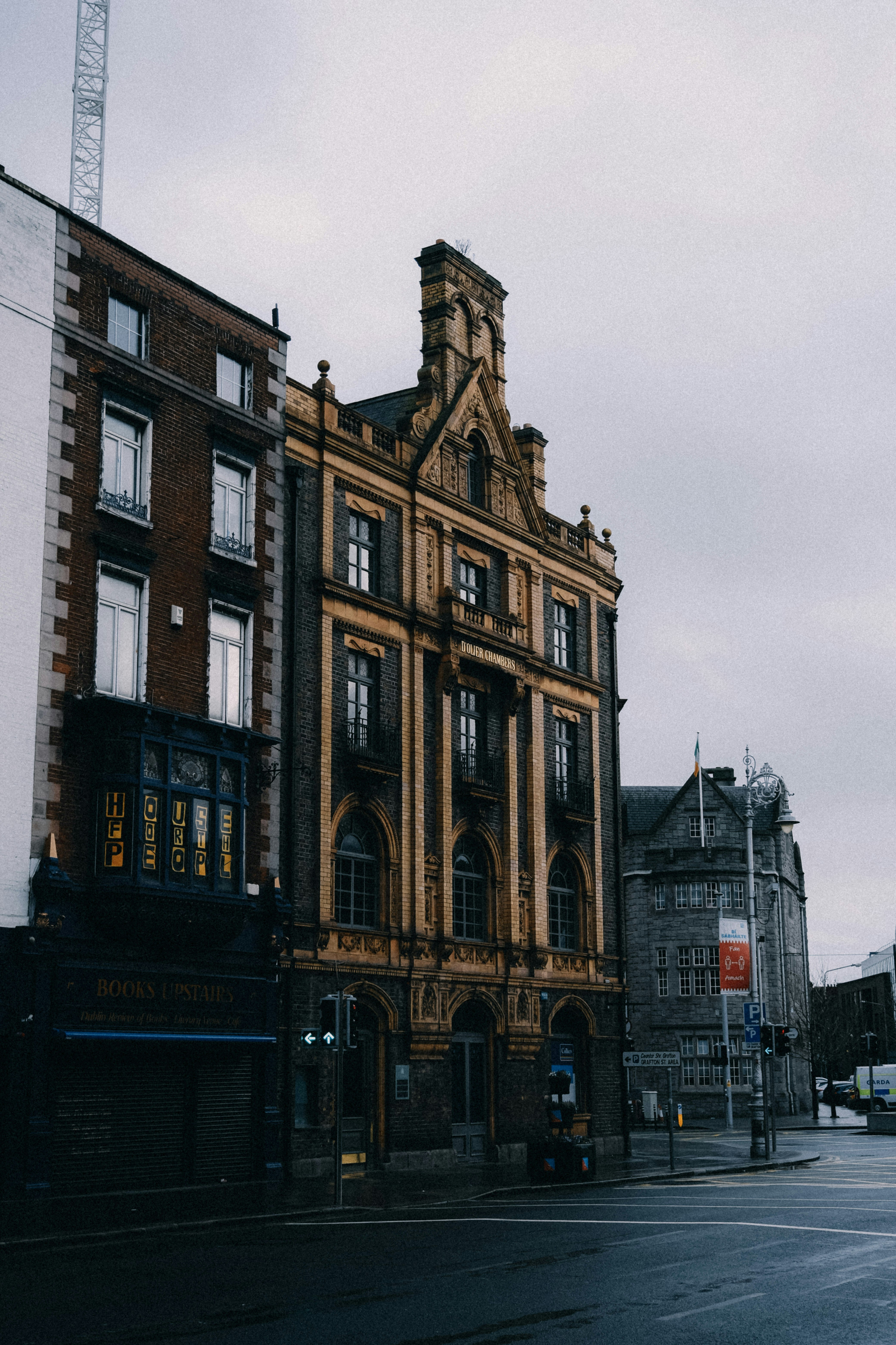 Victorian-style building with intricate details and a weathered facade, standing on a quiet urban street.
