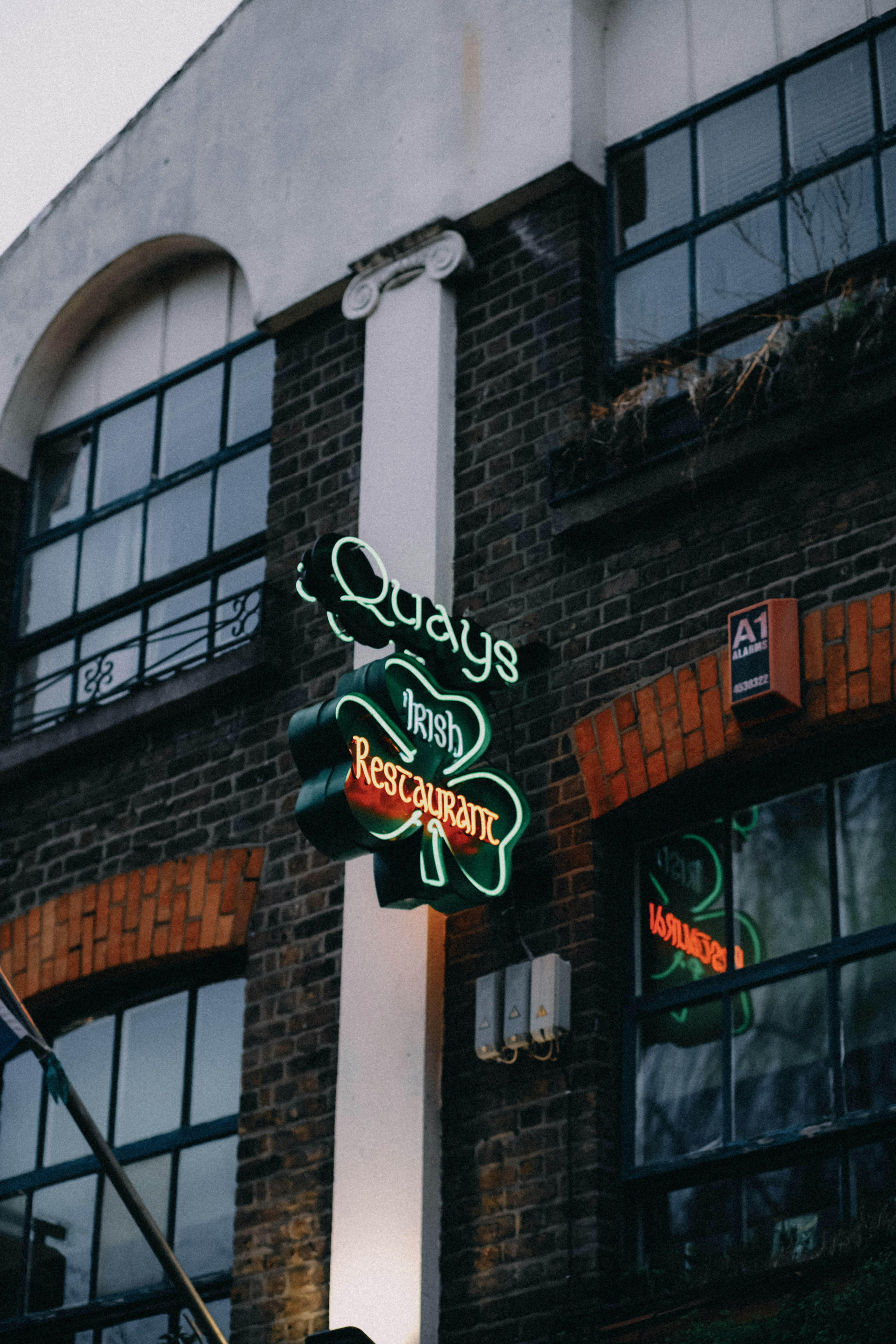 A neon sign on the side of a building photo – Free Dublin Image on Unsplash