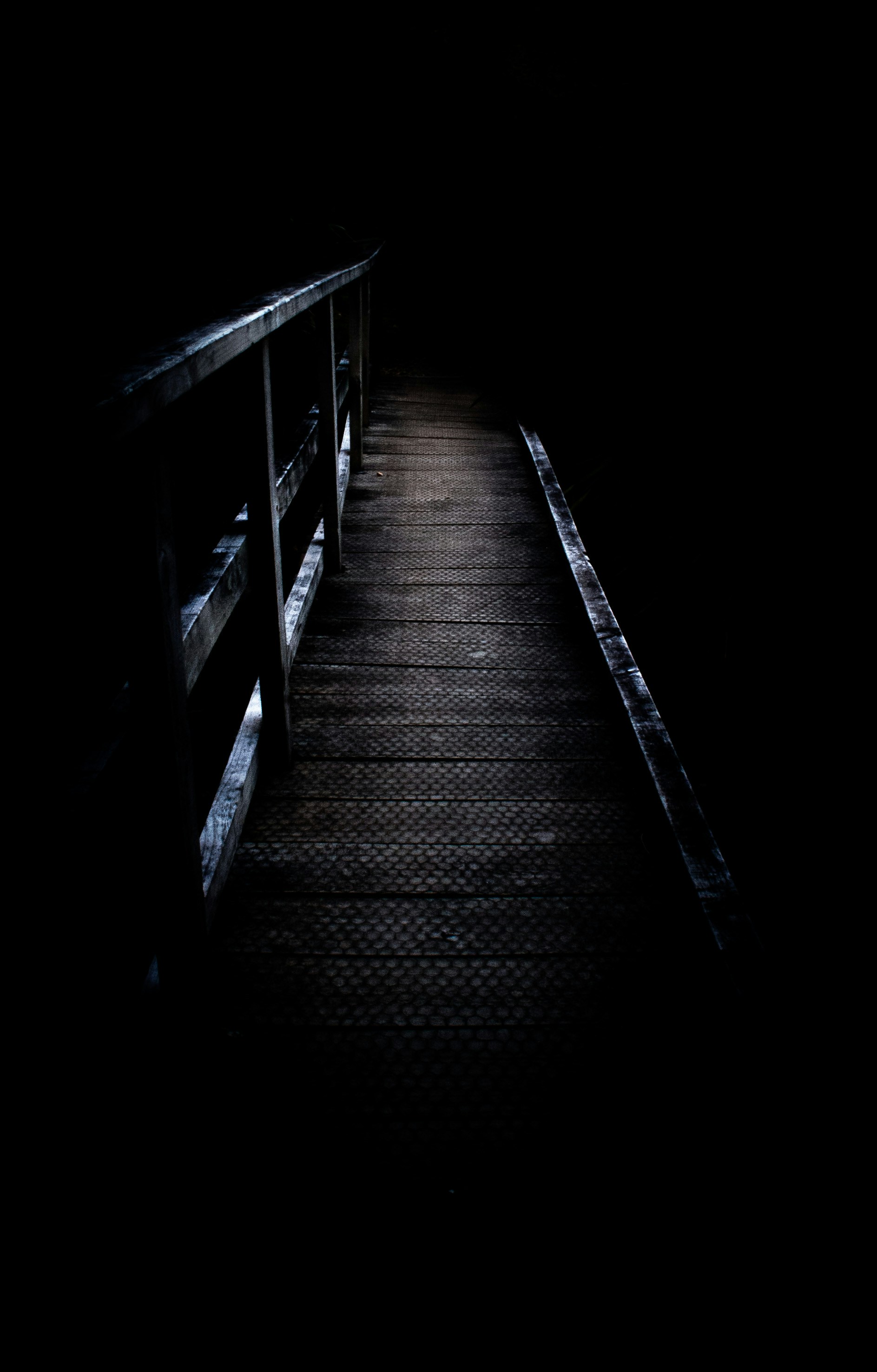 A dark walkway leading to a bench in the dark photo – Free Okiwi bay ...