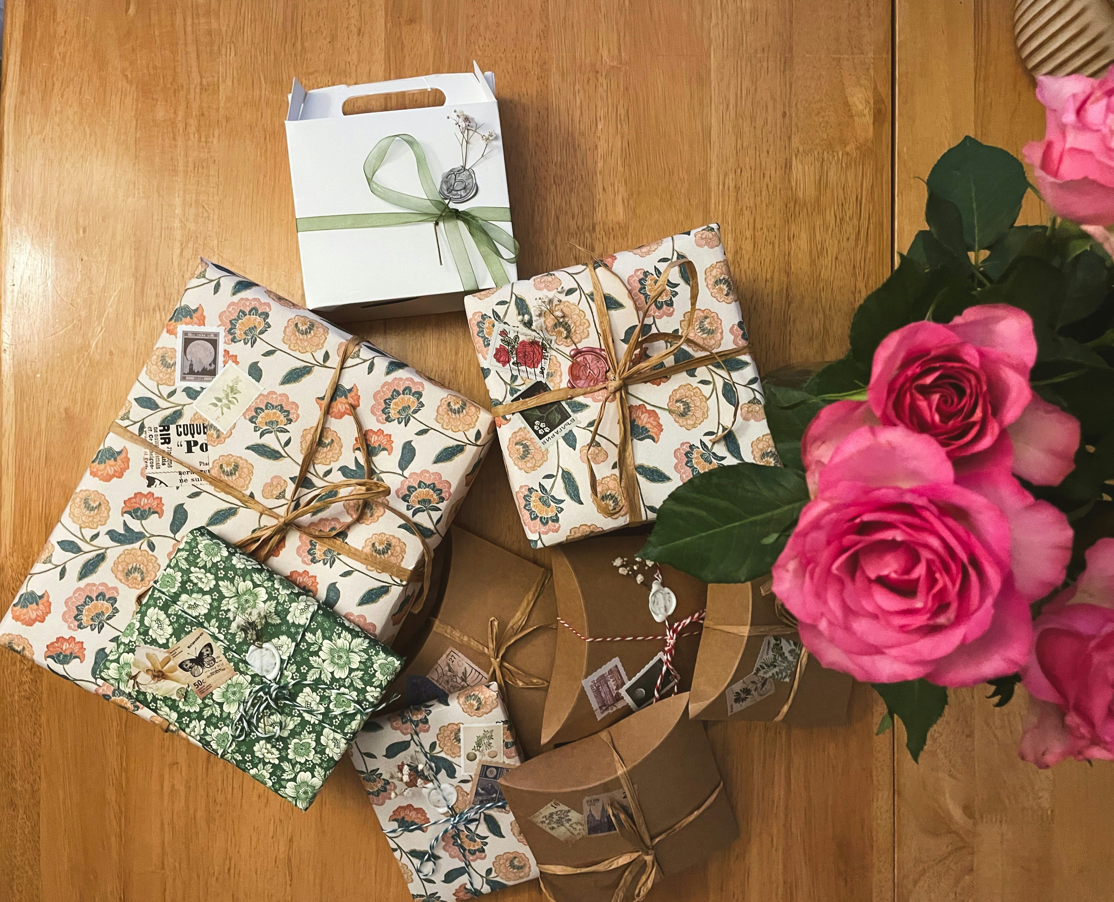 A bunch of wrapping paper sitting on top of a wooden floor photo – Free ...
