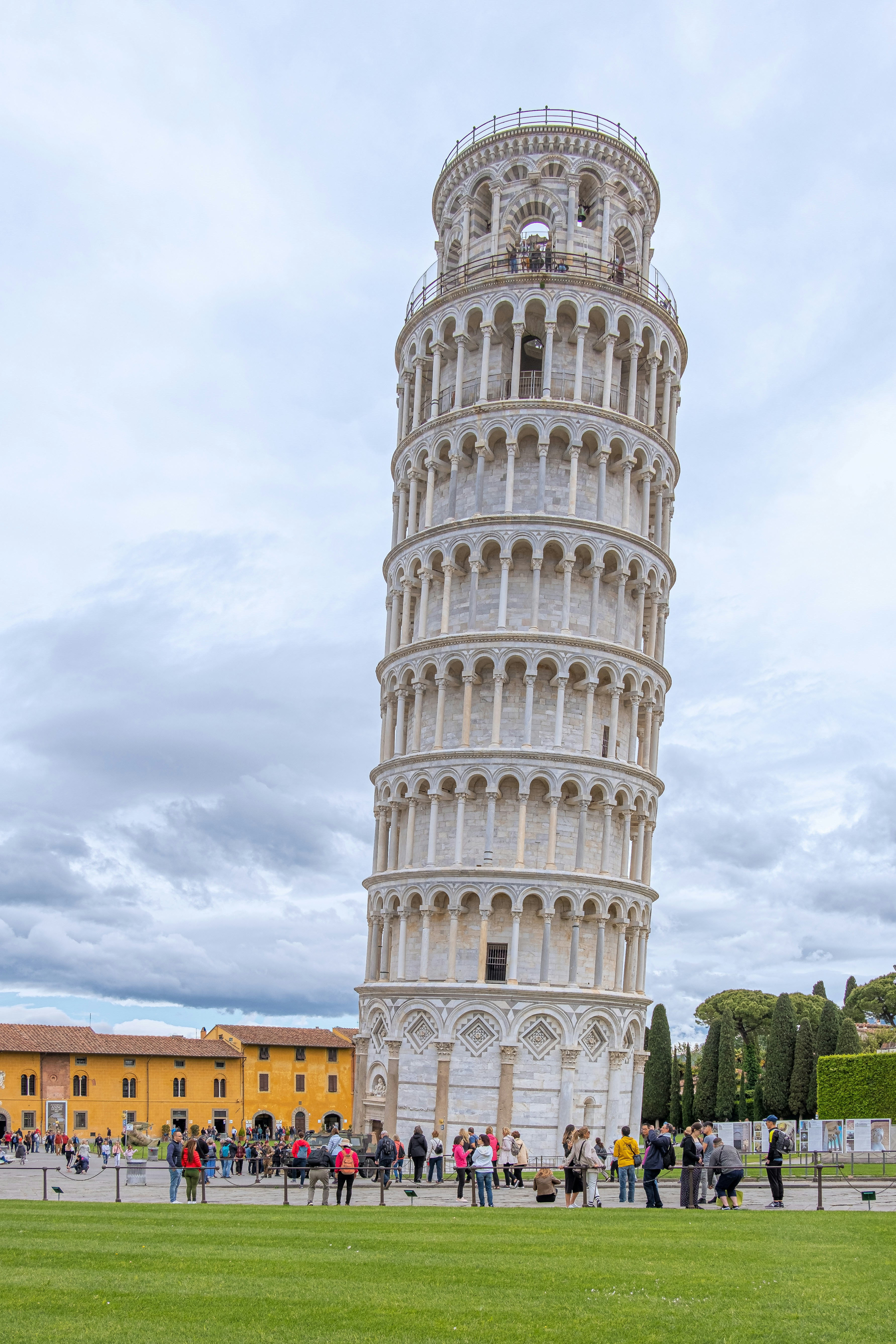 Leaning Marble Spiral: Pisa's Tower Under a Cloudy Sky