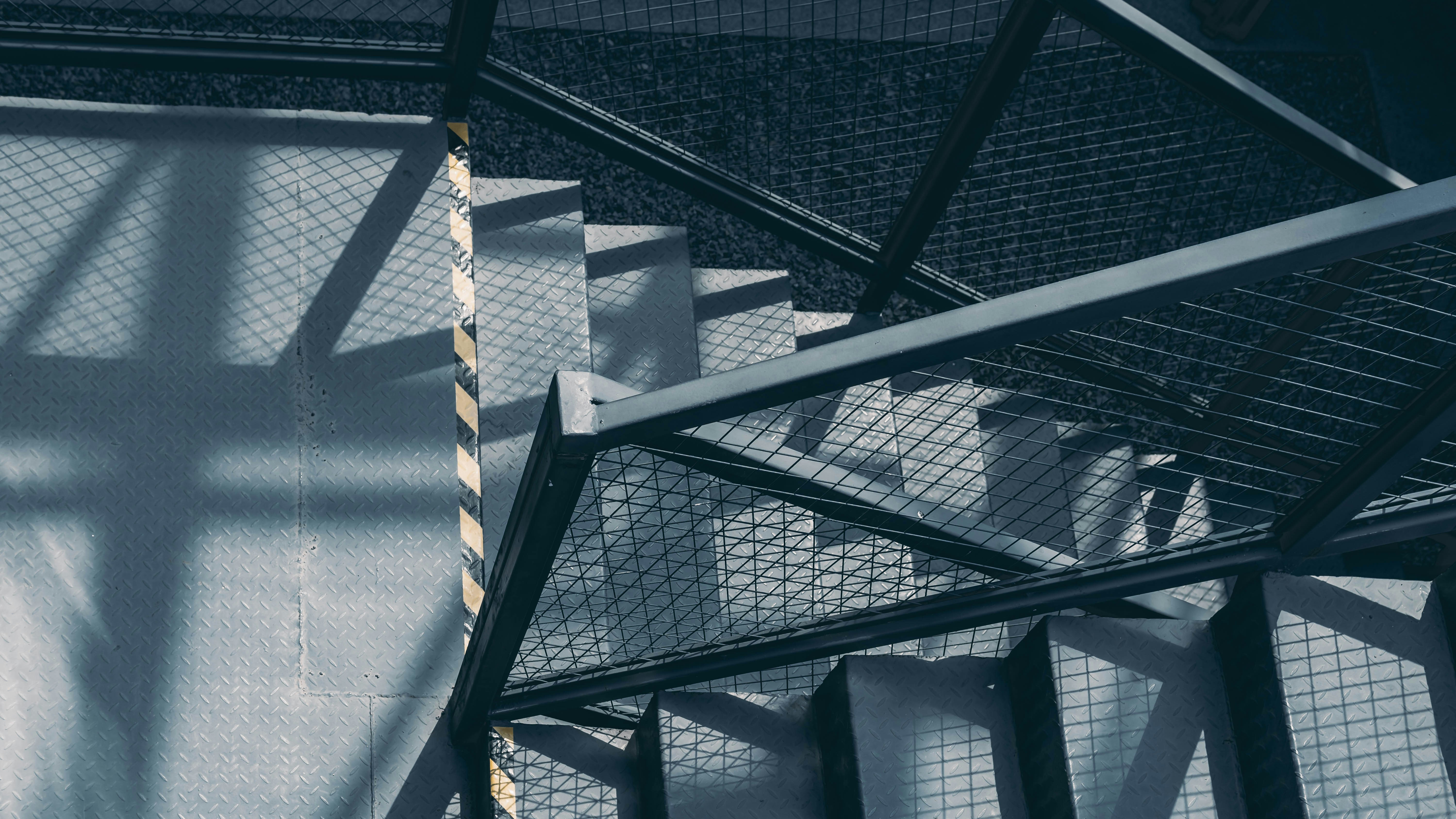 A stair case with metal railings and mesh netting photo – Free 工业 Image ...