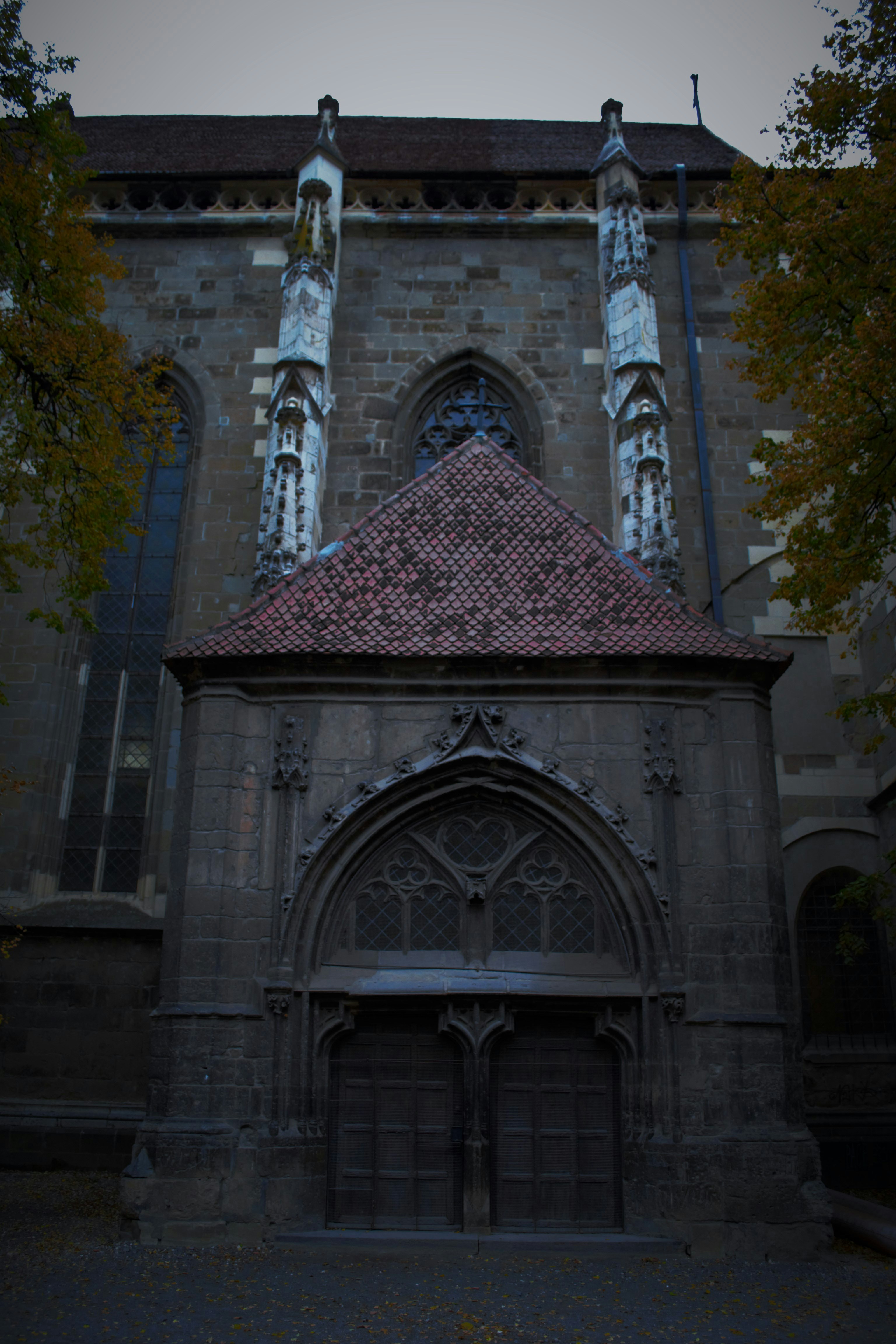 Gothic Portal Under a Red-Tiled Roof at Dusk