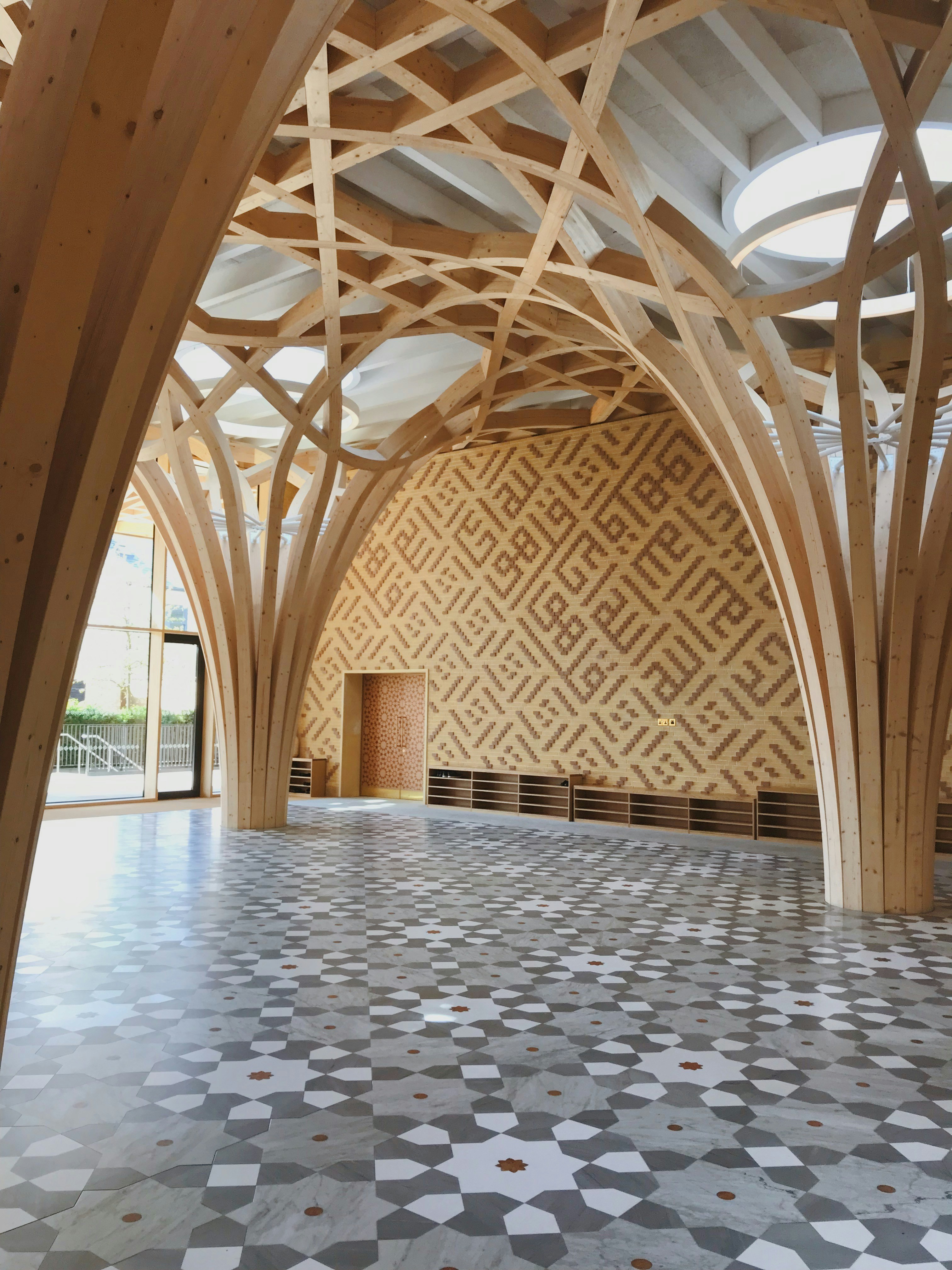 Interwoven Timber Cathedral: Arches, Light, and Geometric Tiles