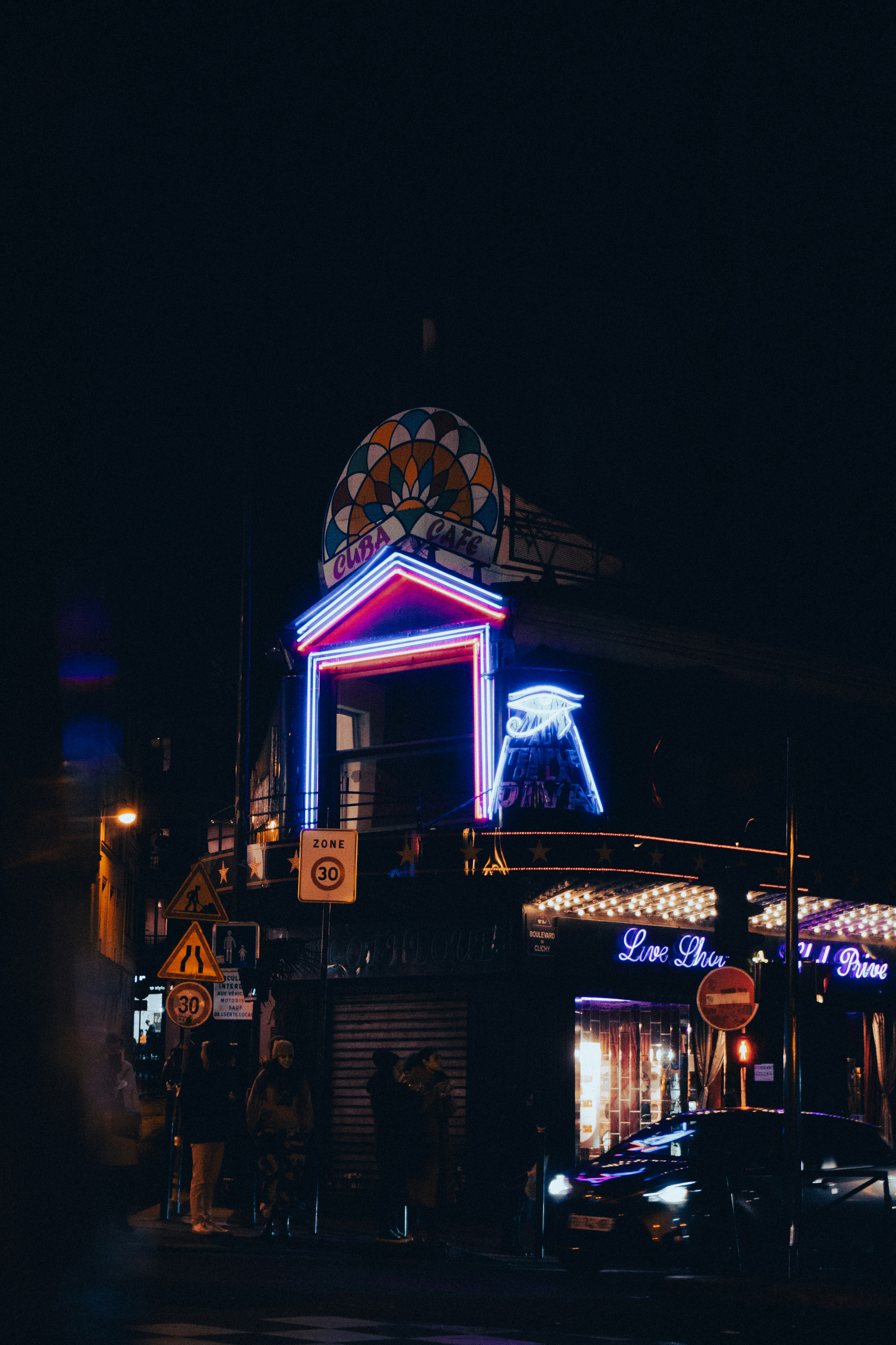 A building with a lit up sign on top of it photo – Free Paris Image on ...