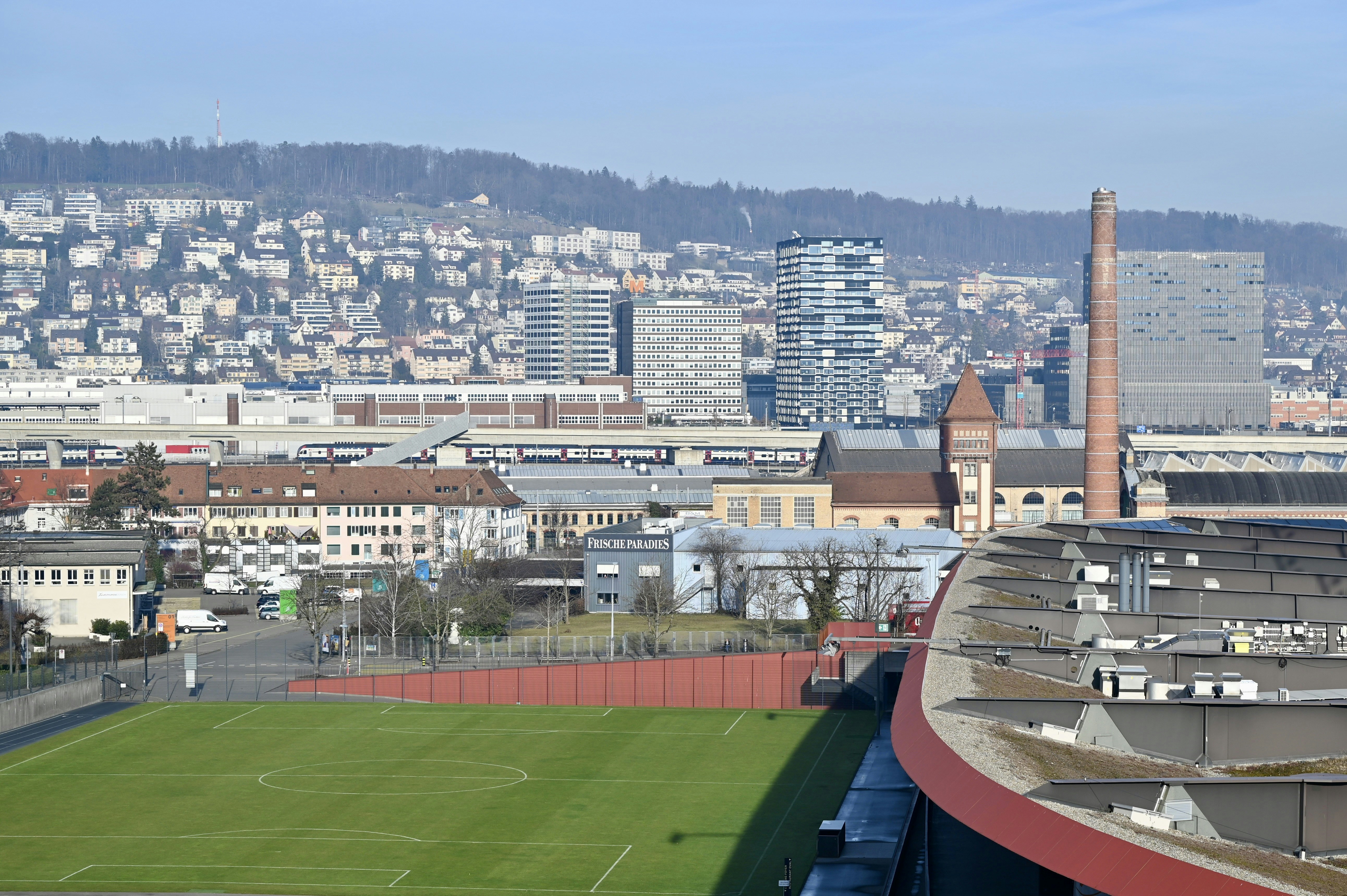 A soccer field in front of a city photo – Free Letzigrund Image on Unsplash