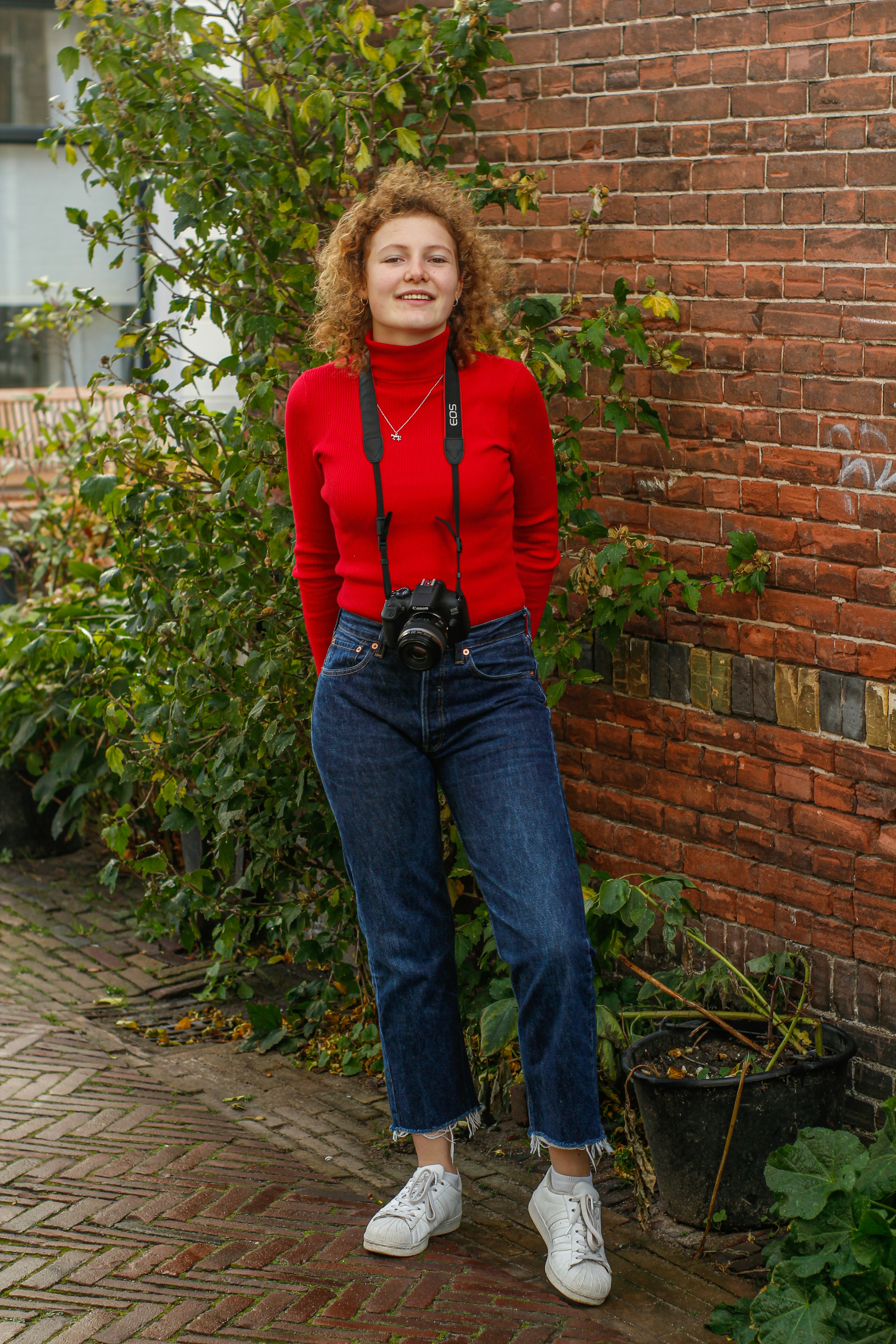 Red Turtleneck Portrait: Camera at the Neck, Brick Wall Backdrop
