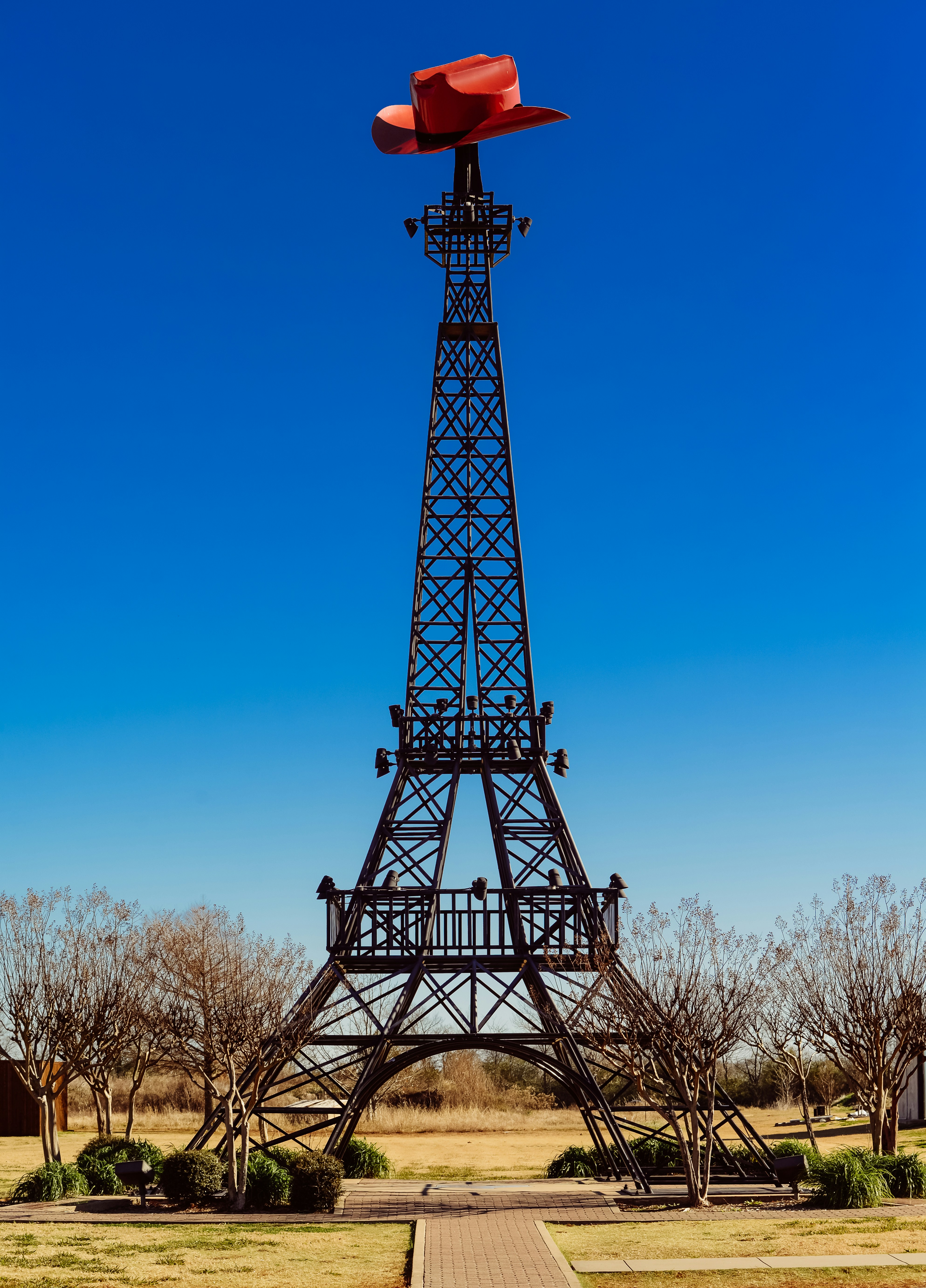 Red Cowboy Hat Crowned Tower Under a Cerulean Sky