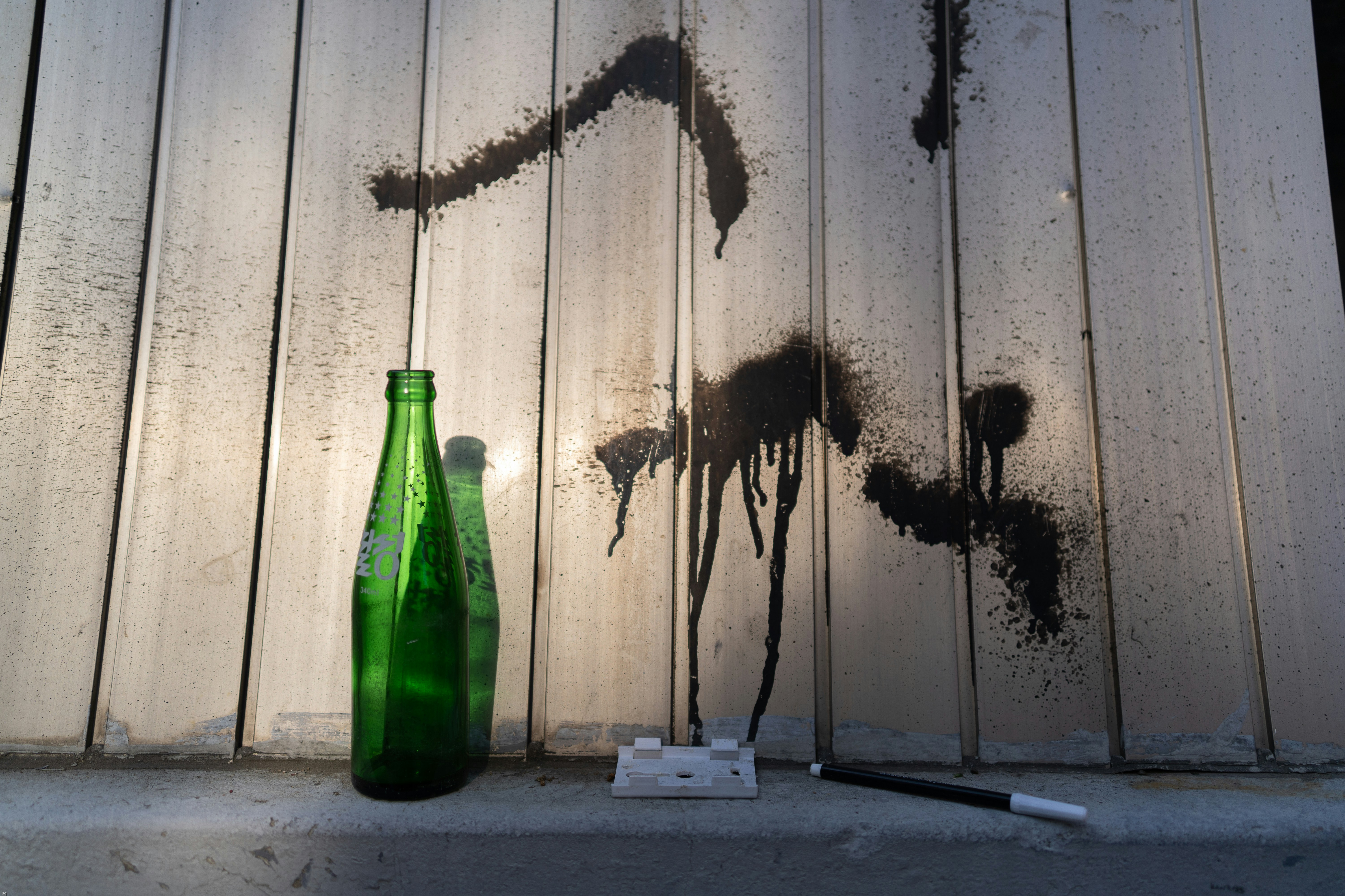 An empty bottle and... something