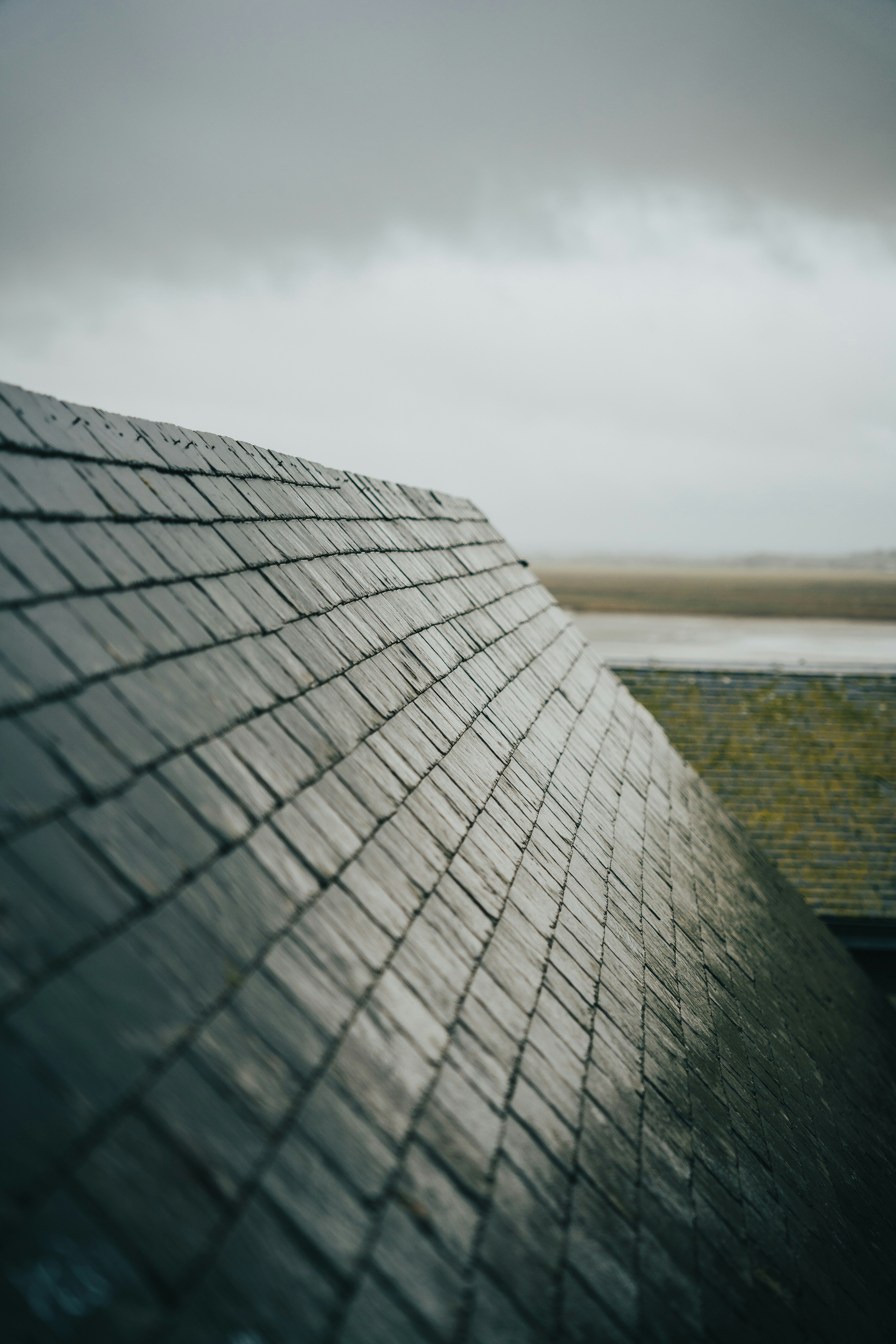 Curved Slate Roof: Weathered Tile Lines Receding into a Misty Horizon