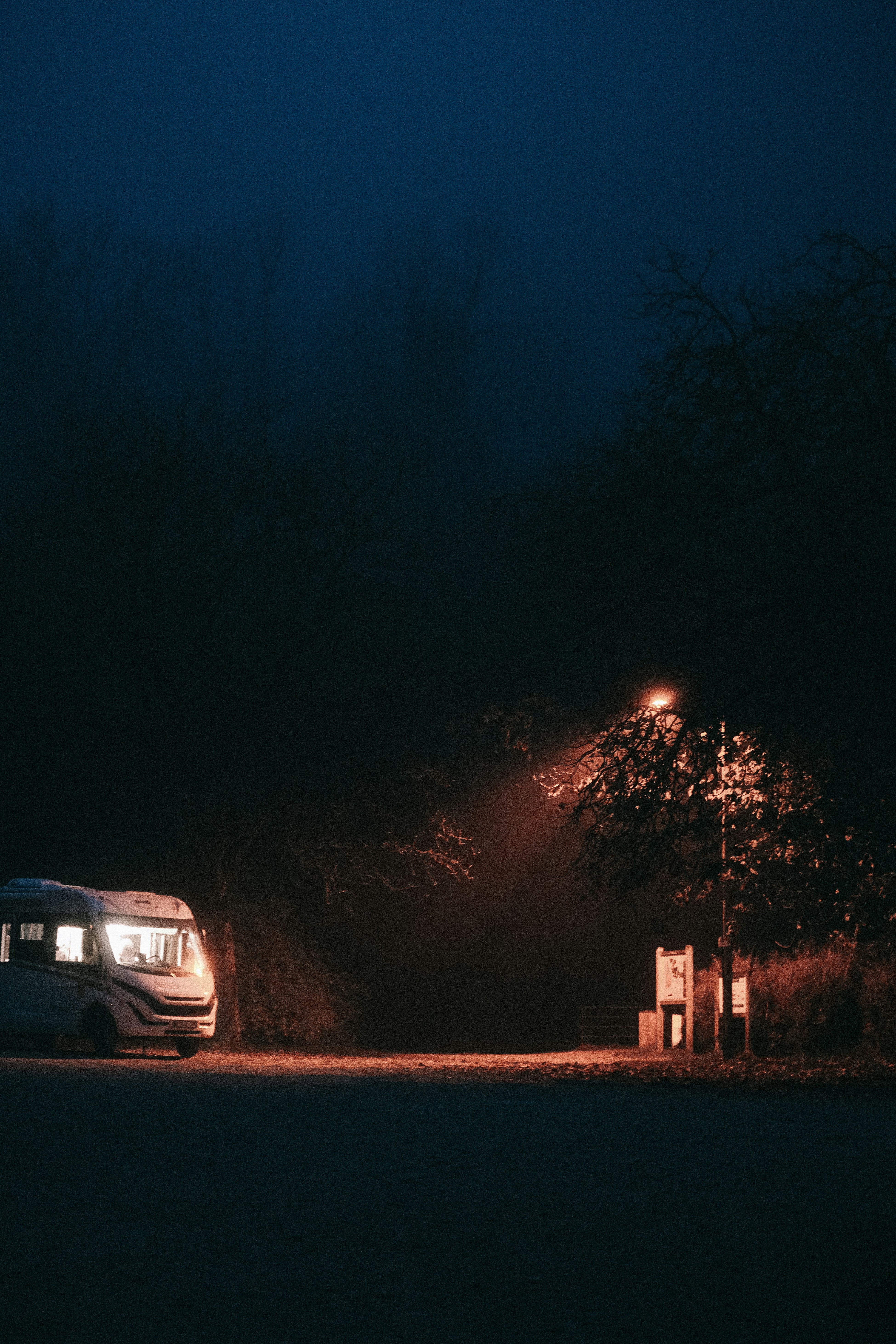 Warm Glow at the Quiet RV Stop Under a Lone Streetlamp