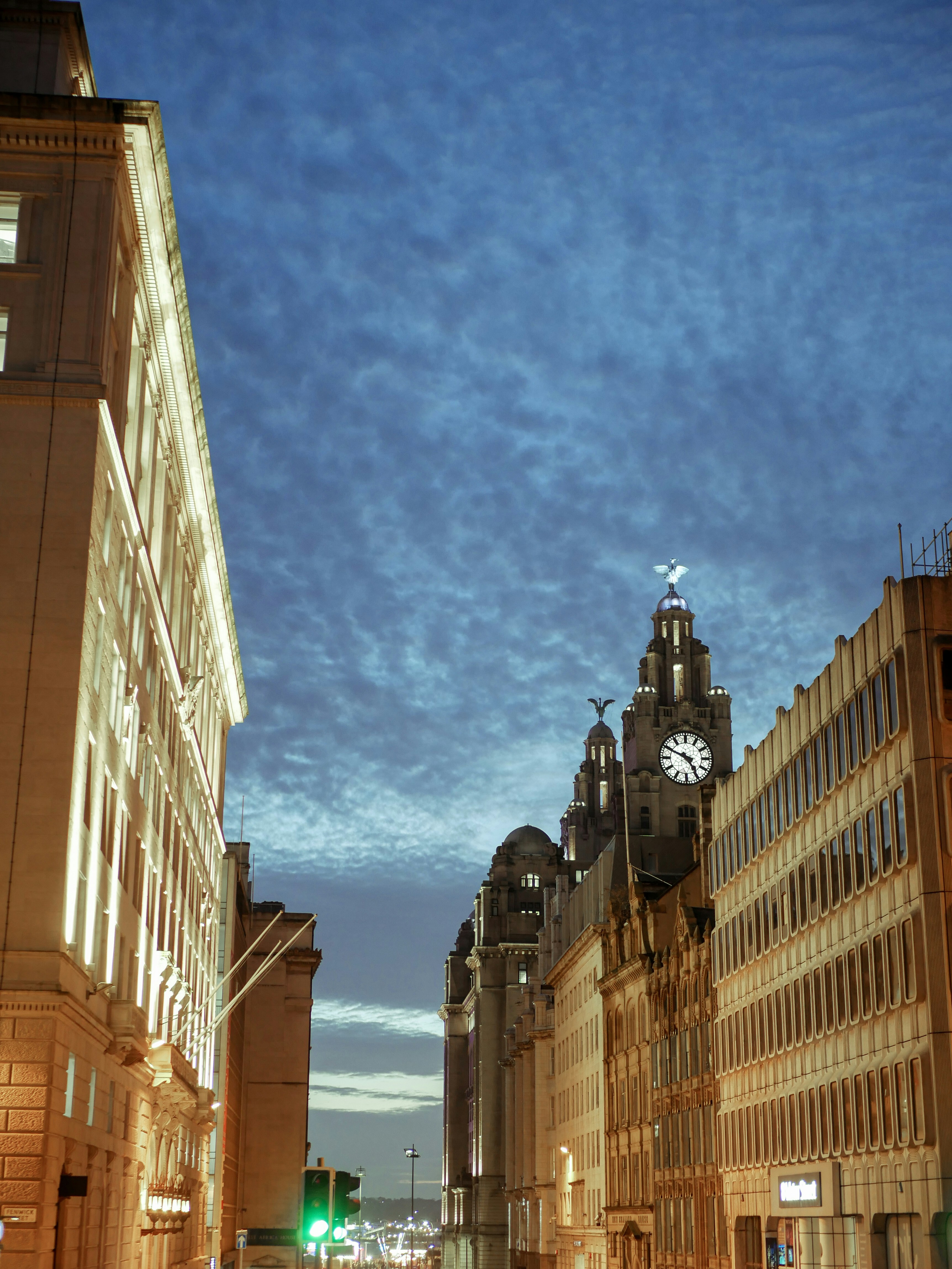 A city street with tall buildings and a clock tower photo – Free Cunard ...