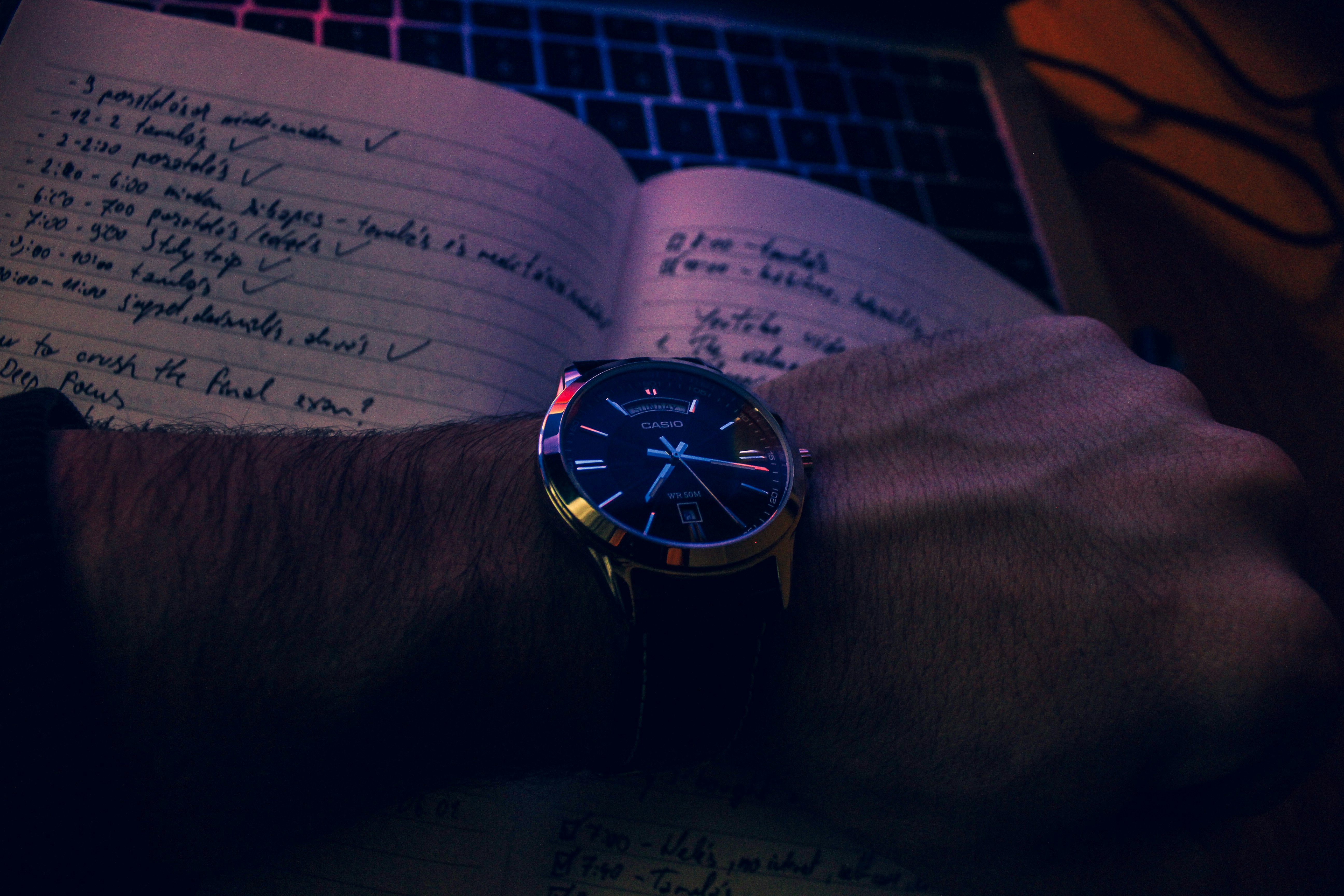 Nocturnal Timekeeper: A Wristwatch Illuminates a Quiet Page